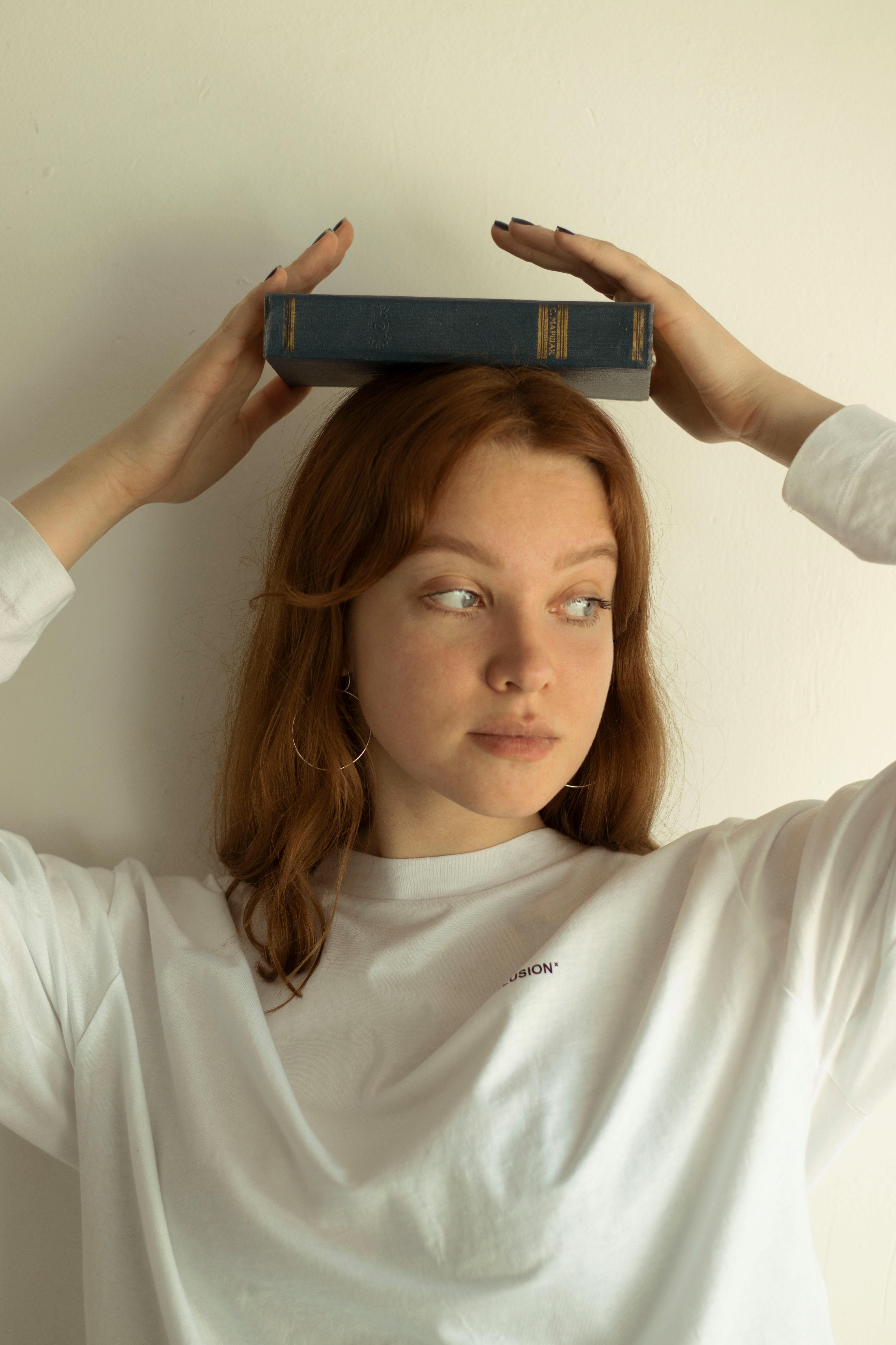 Intelligent student in eyeglasses with book in sunlight · Free Stock Photo