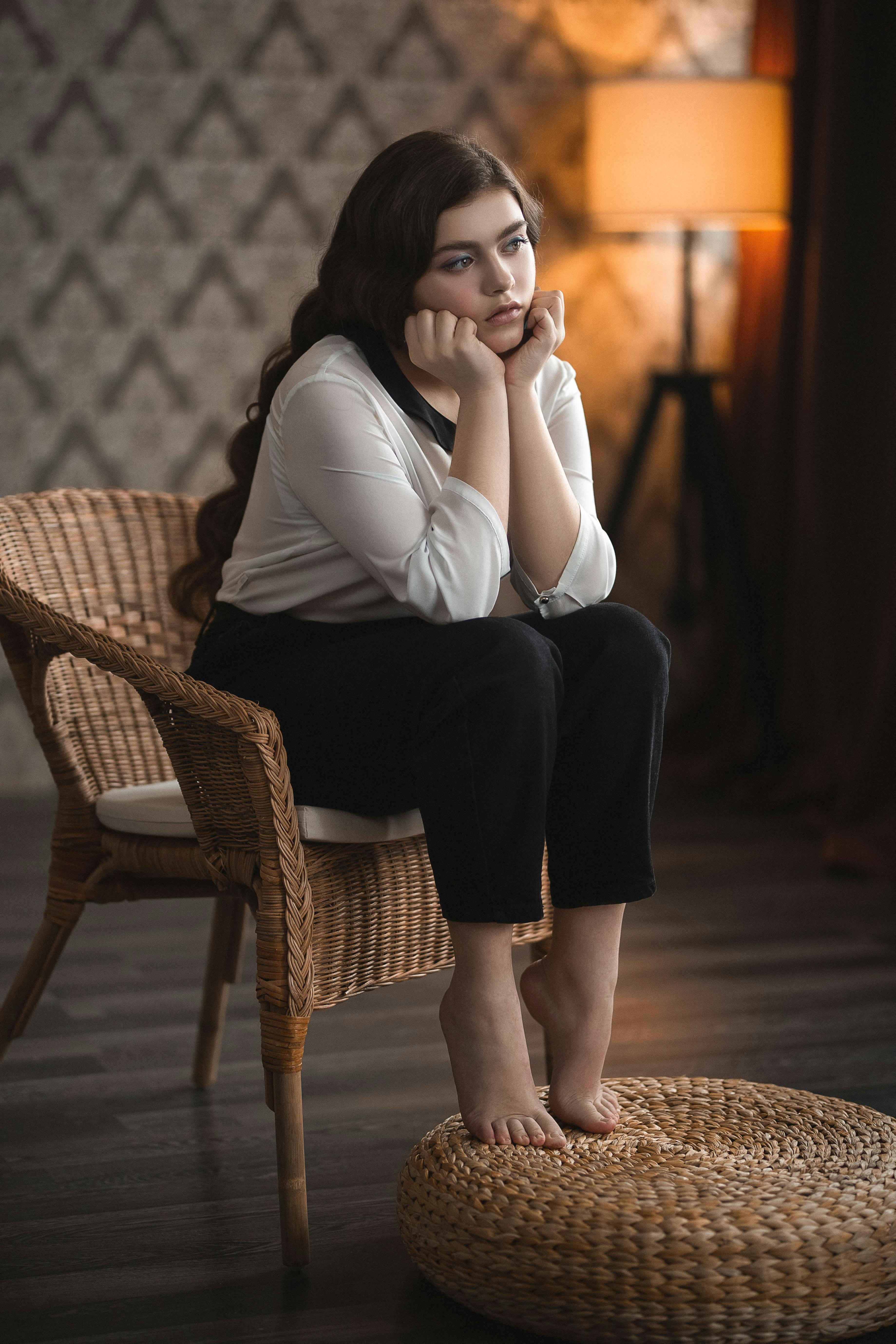 Pensive Young Woman leaning on Wooden Handrail · Free Stock Photo