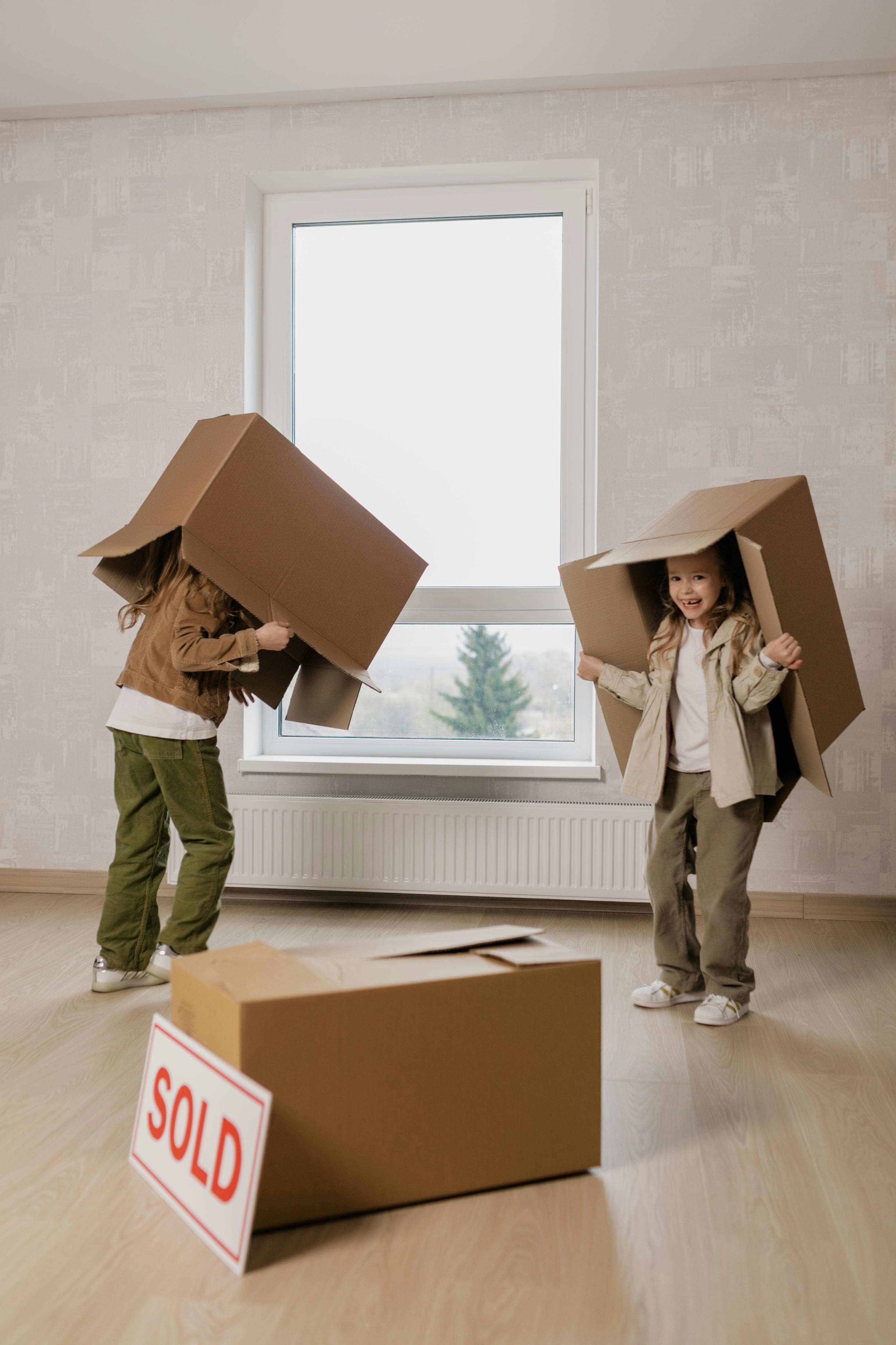 Kids Playing with Cardboard Boxes · Free Stock Photo