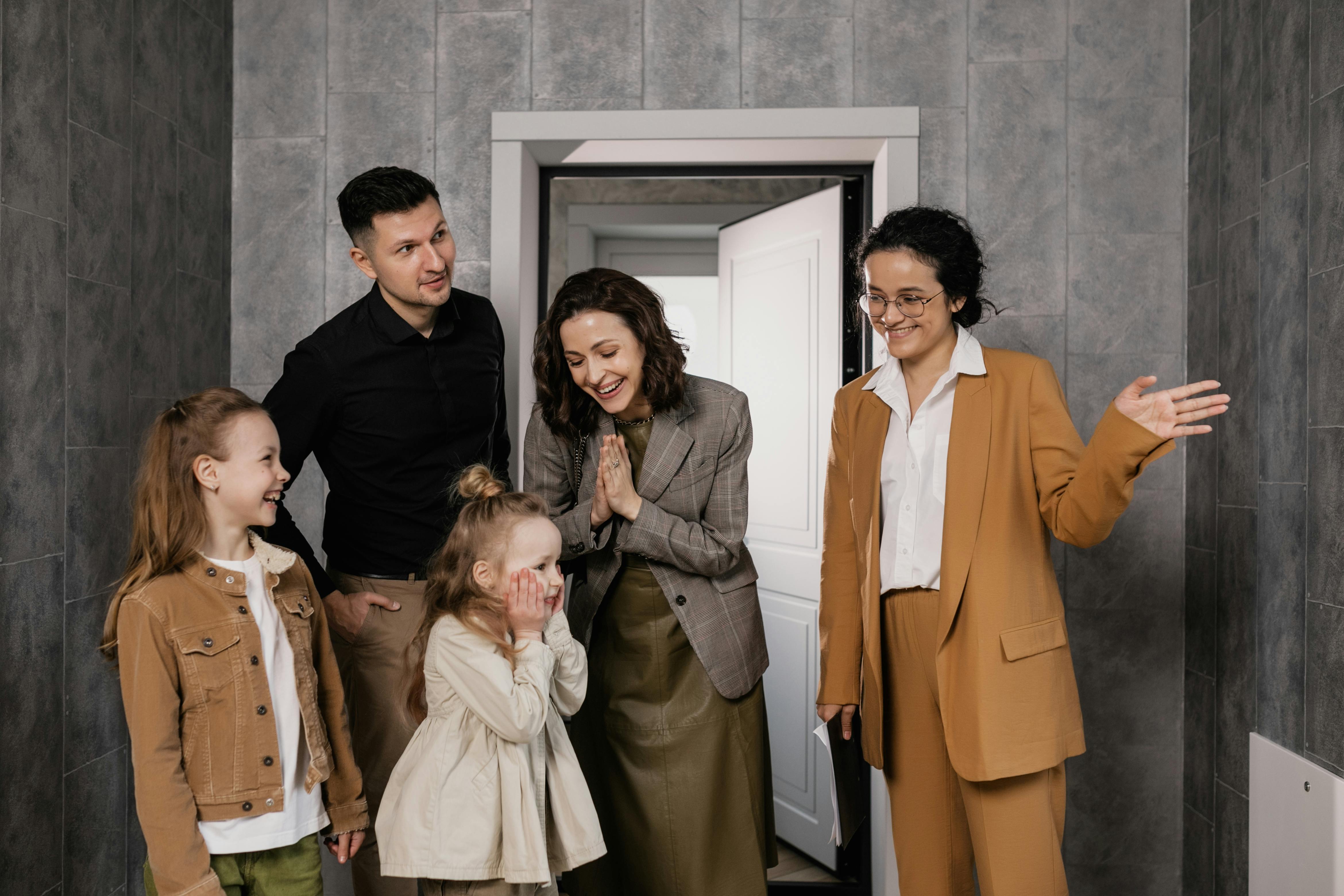 A Realtor Showing a House to a Family · Free Stock Photo