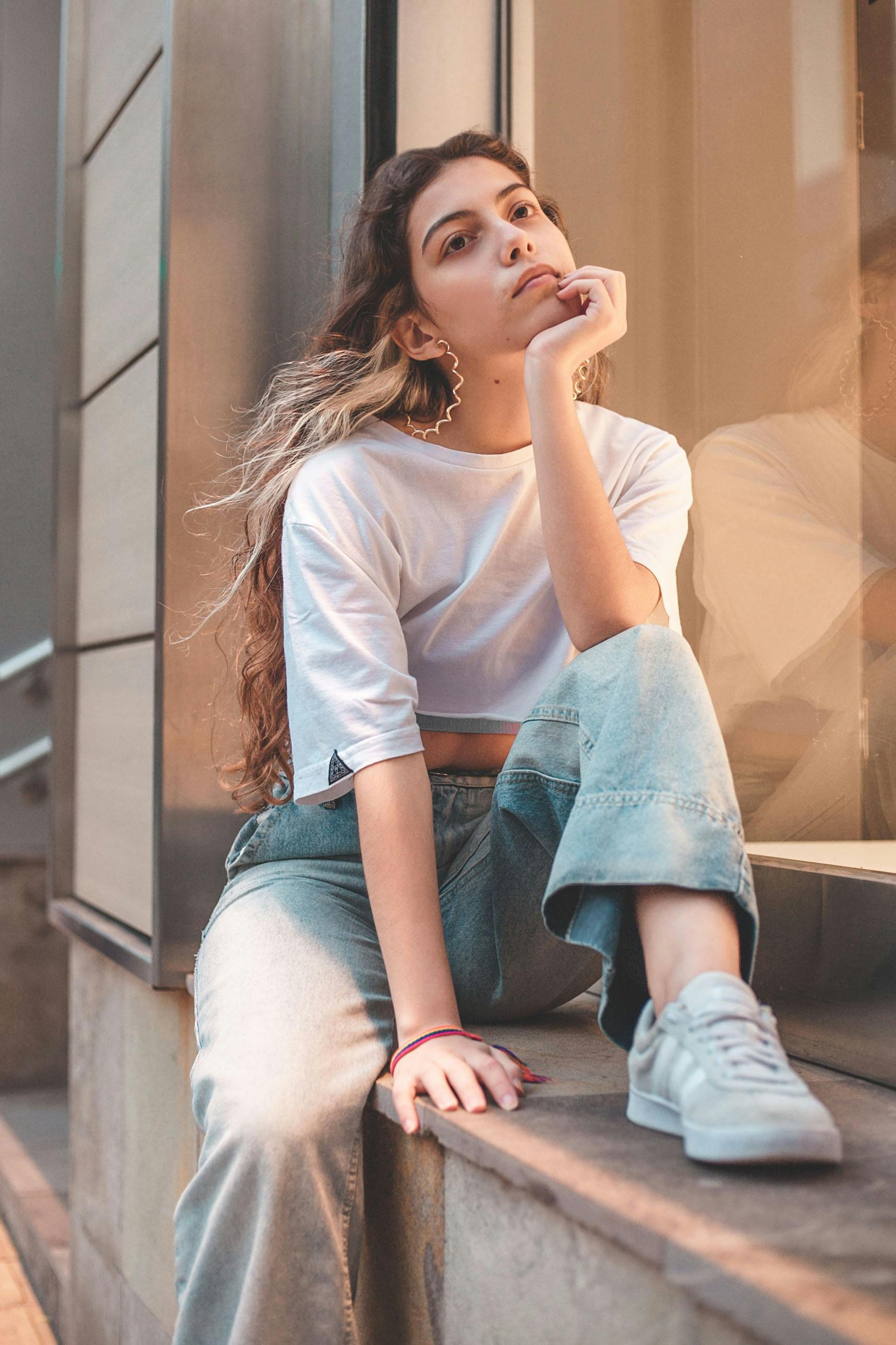 A Man Sitting on Ledge of a Rooftop · Free Stock Photo