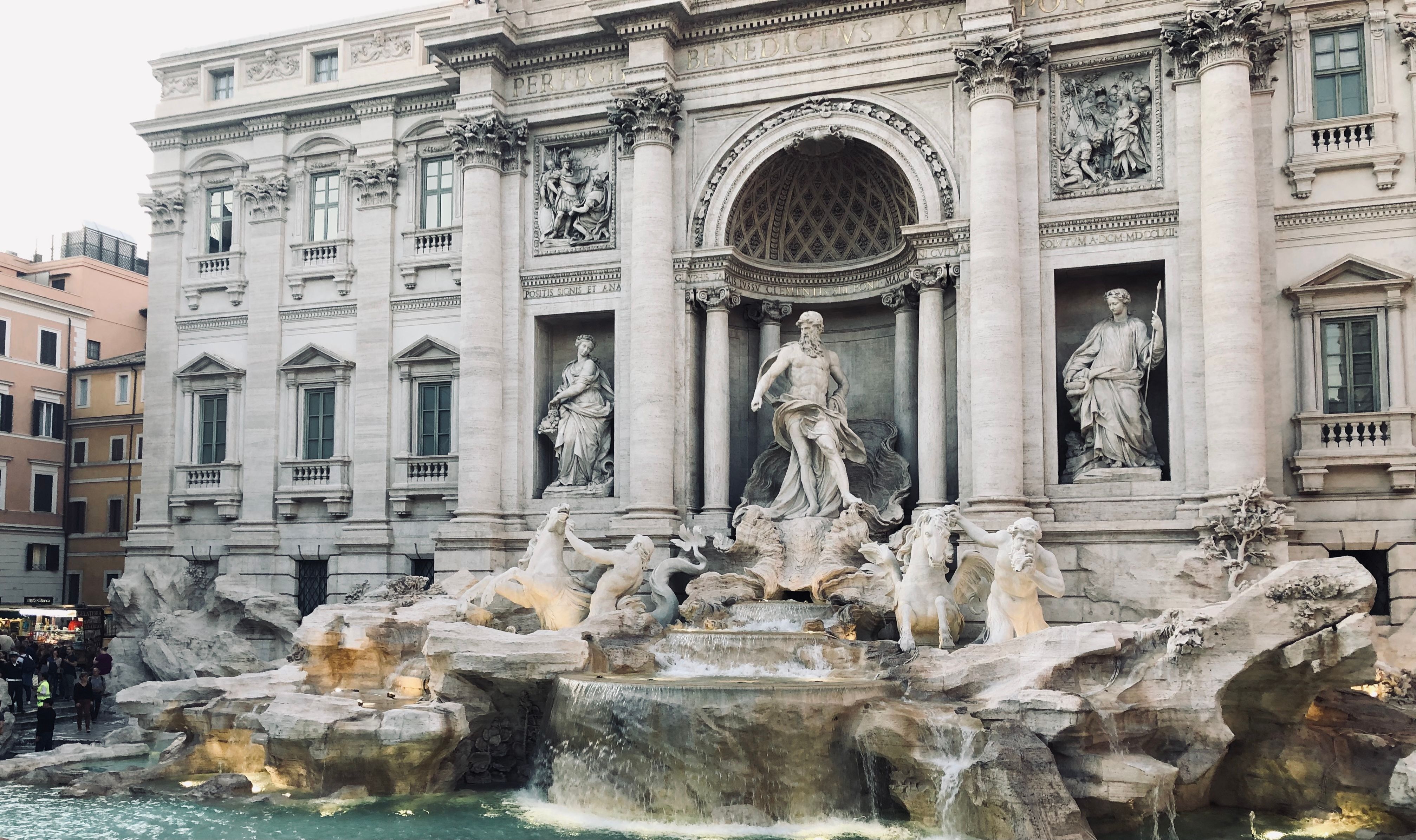 Man Walking Near Statues · Free Stock Photo