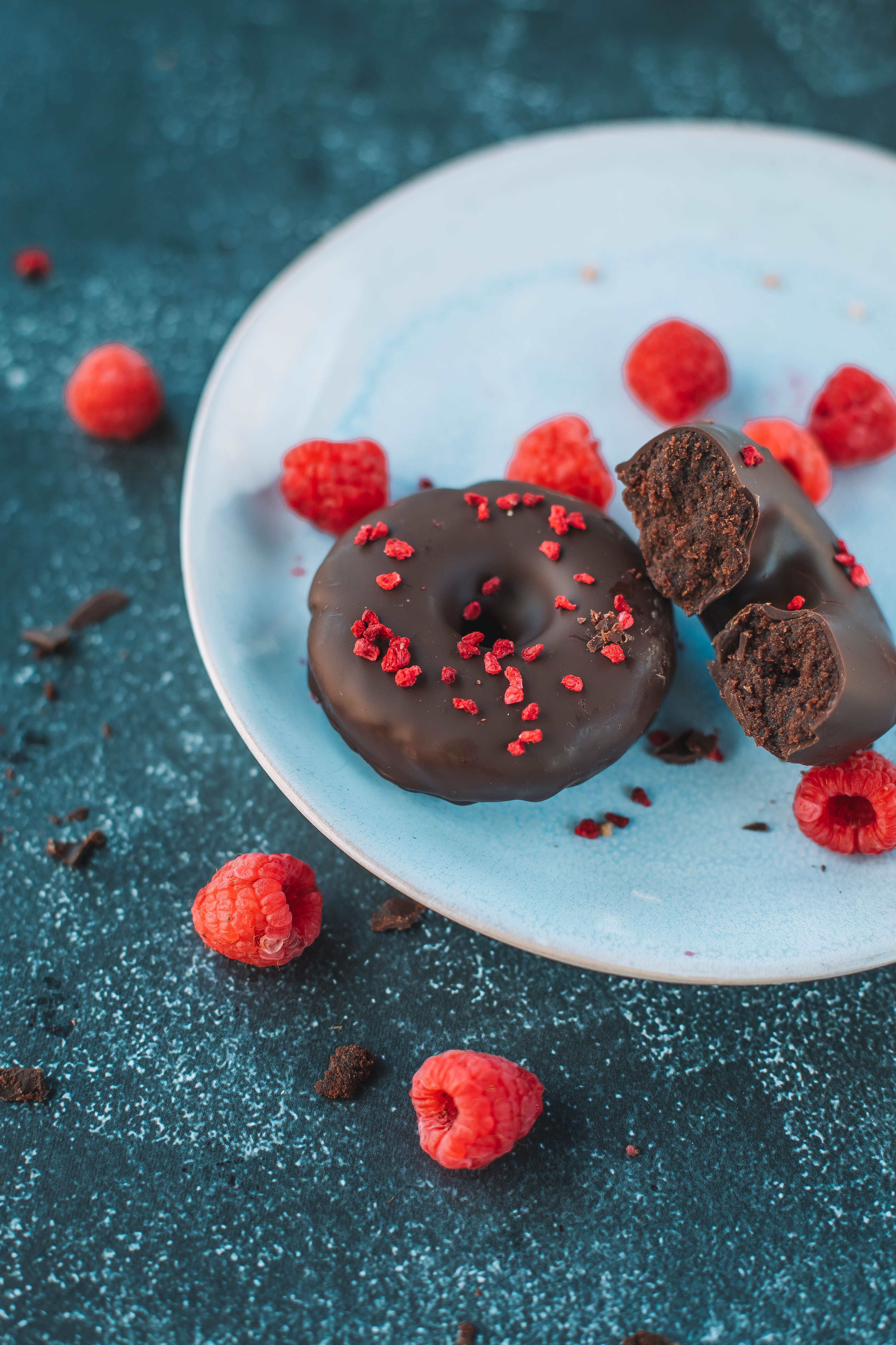 Glazed chocolate doughnuts with raspberry · Free Stock Photo