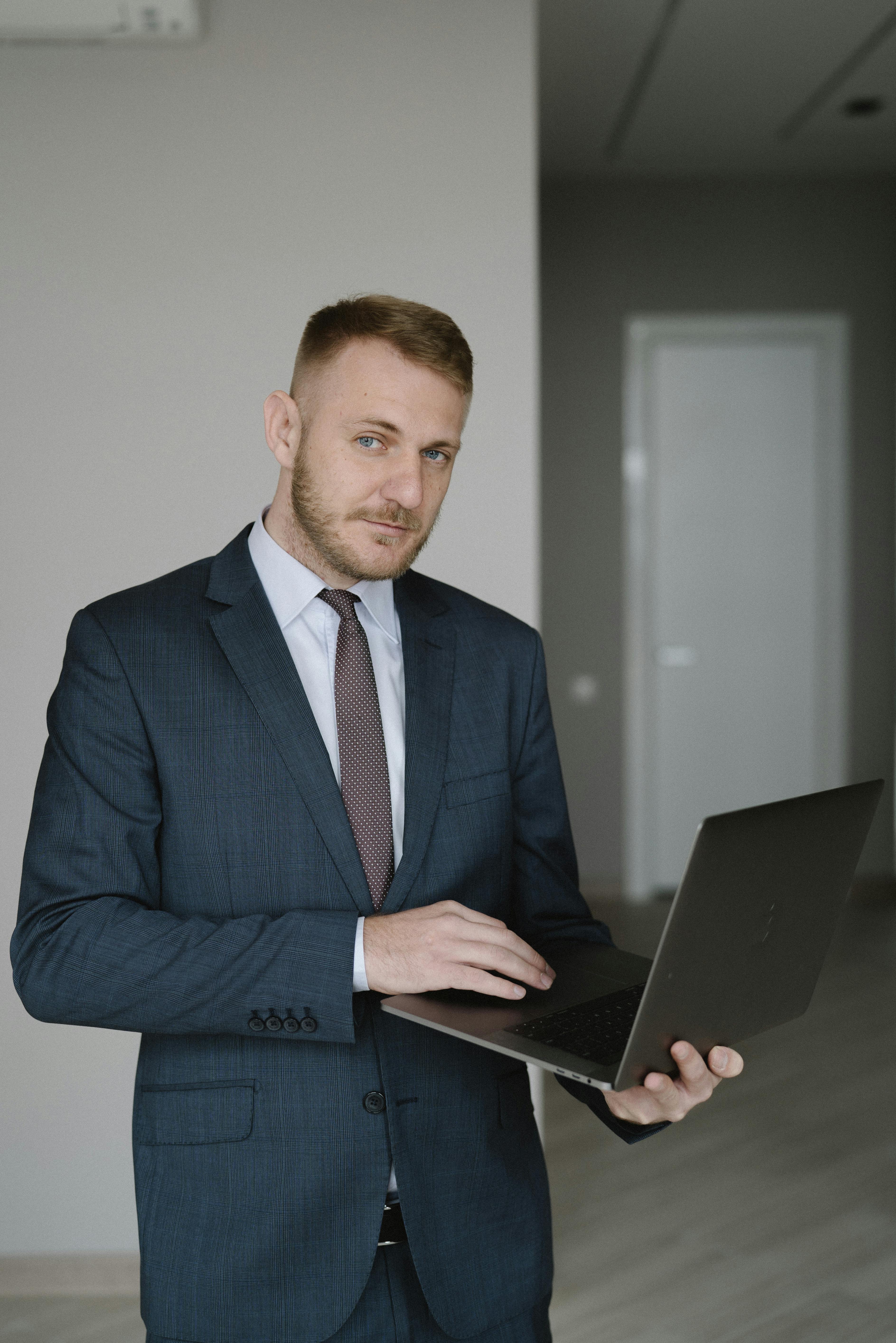 Man in Brown Blazer Holding Tablet Computer · Free Stock Photo