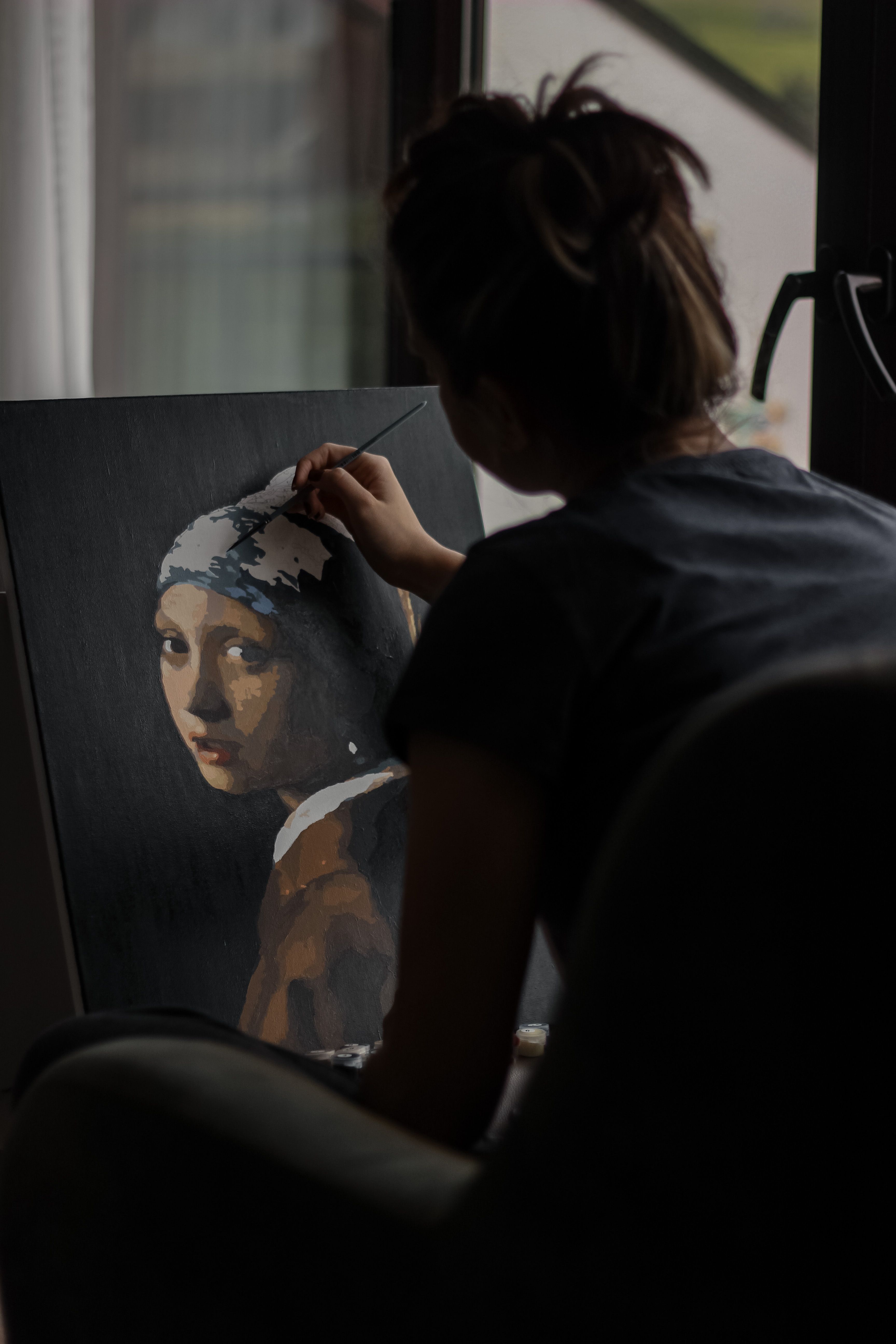 Back View of a Painter Painting on a Canvas · Free Stock Photo