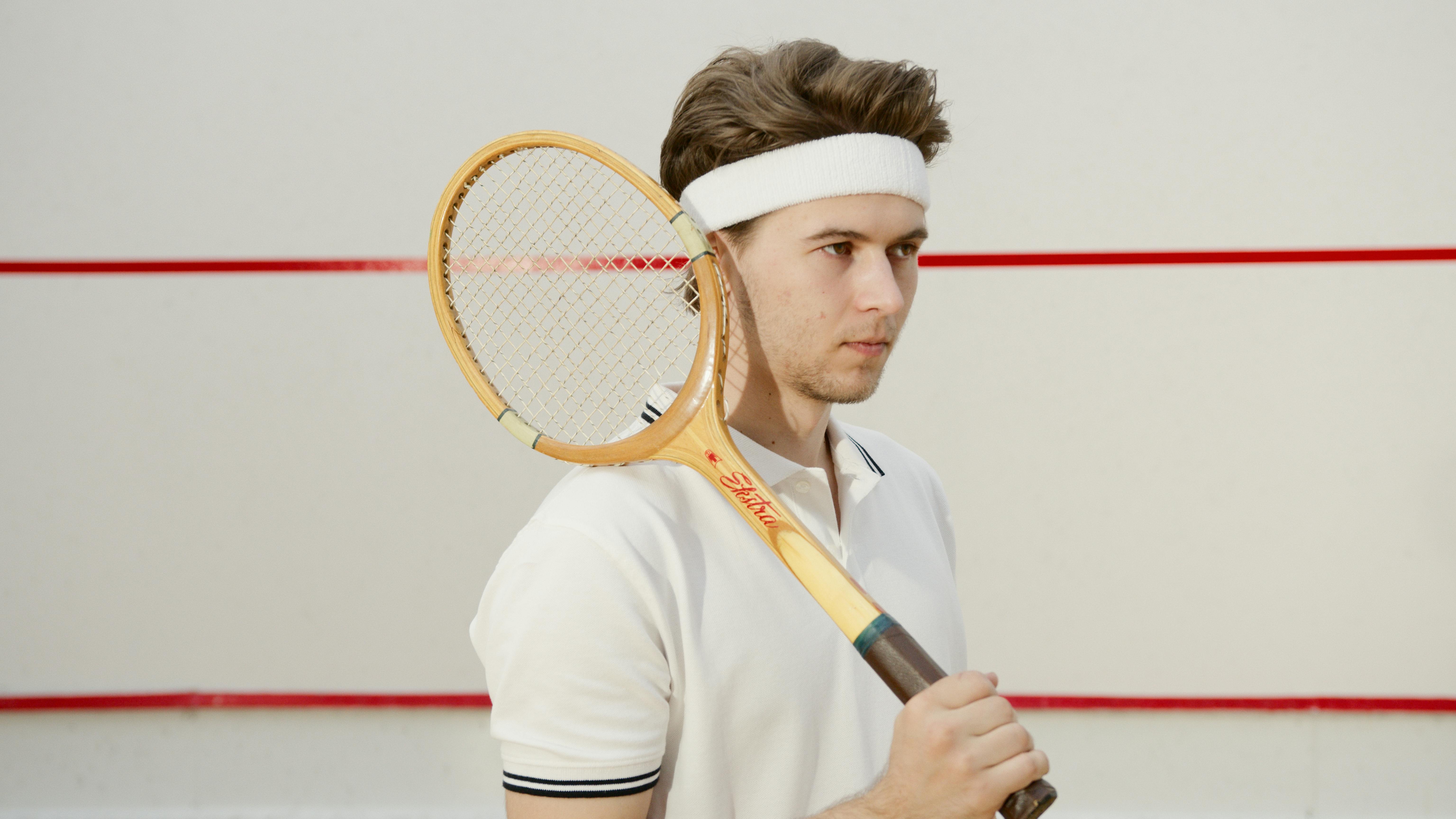 A Man Holding a Tennis Racket · Free Stock Photo