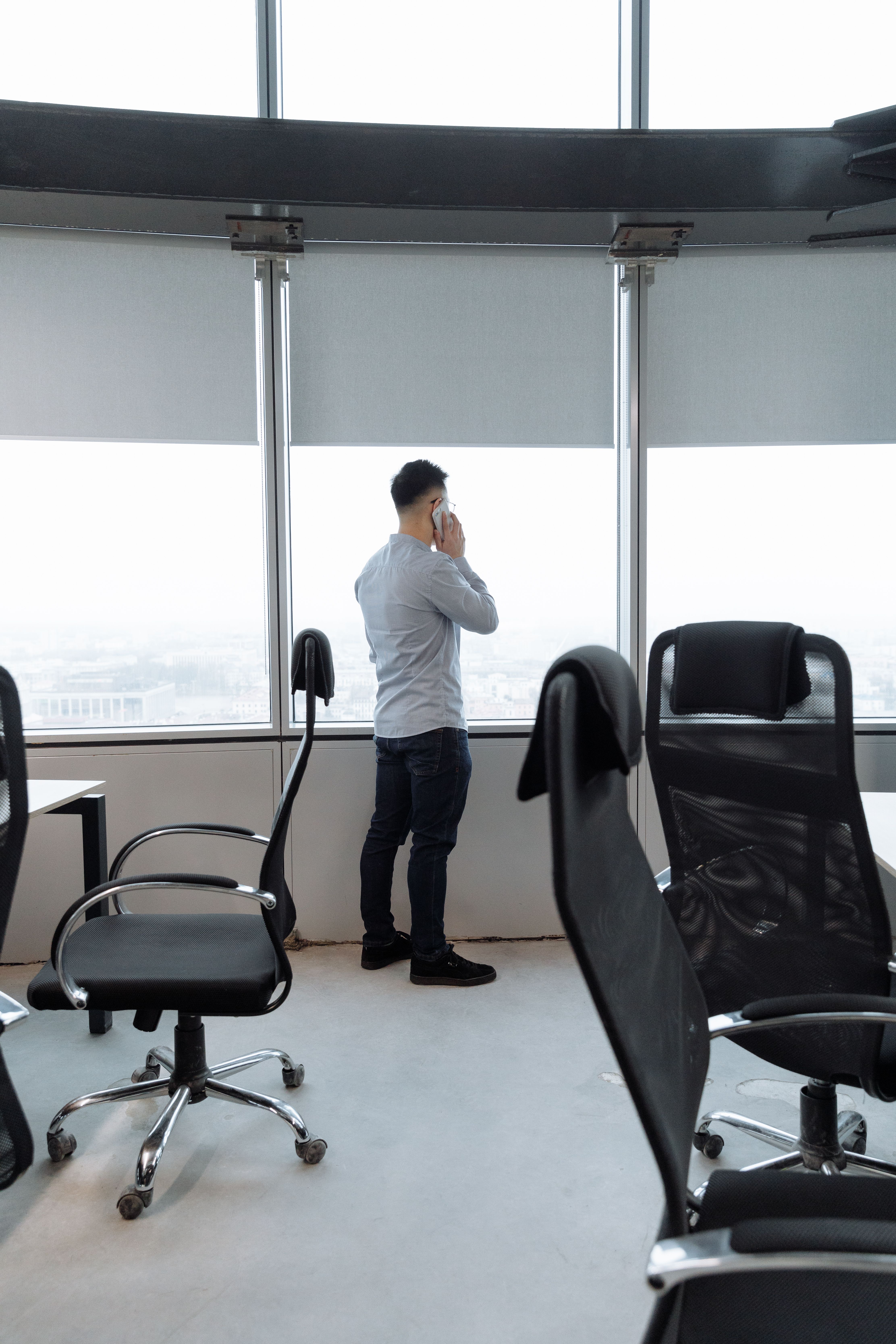 A Man in an Office Having a Phone Call · Free Stock Photo