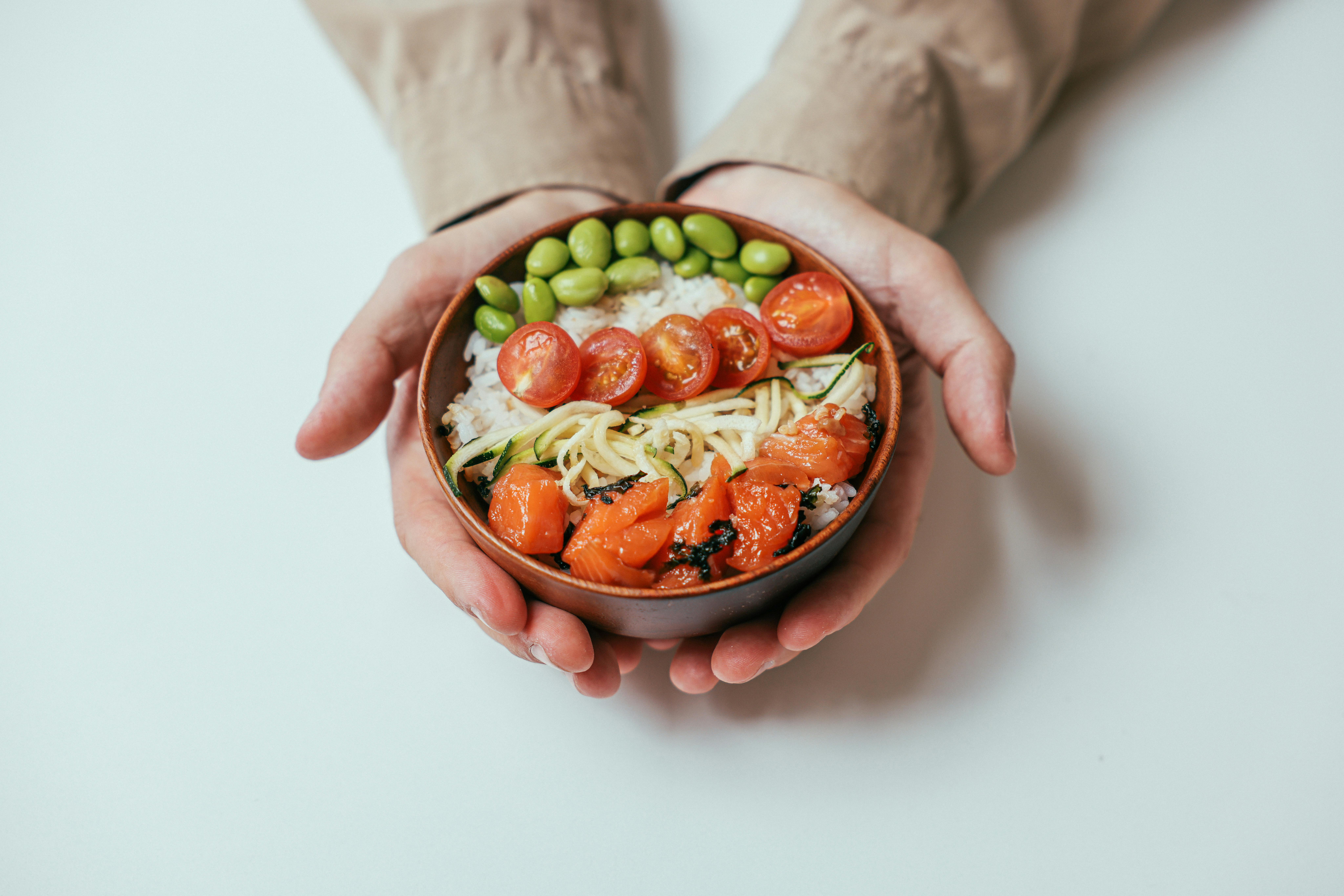 Person Holding a Rice Bowl with Toppings · Free Stock Photo