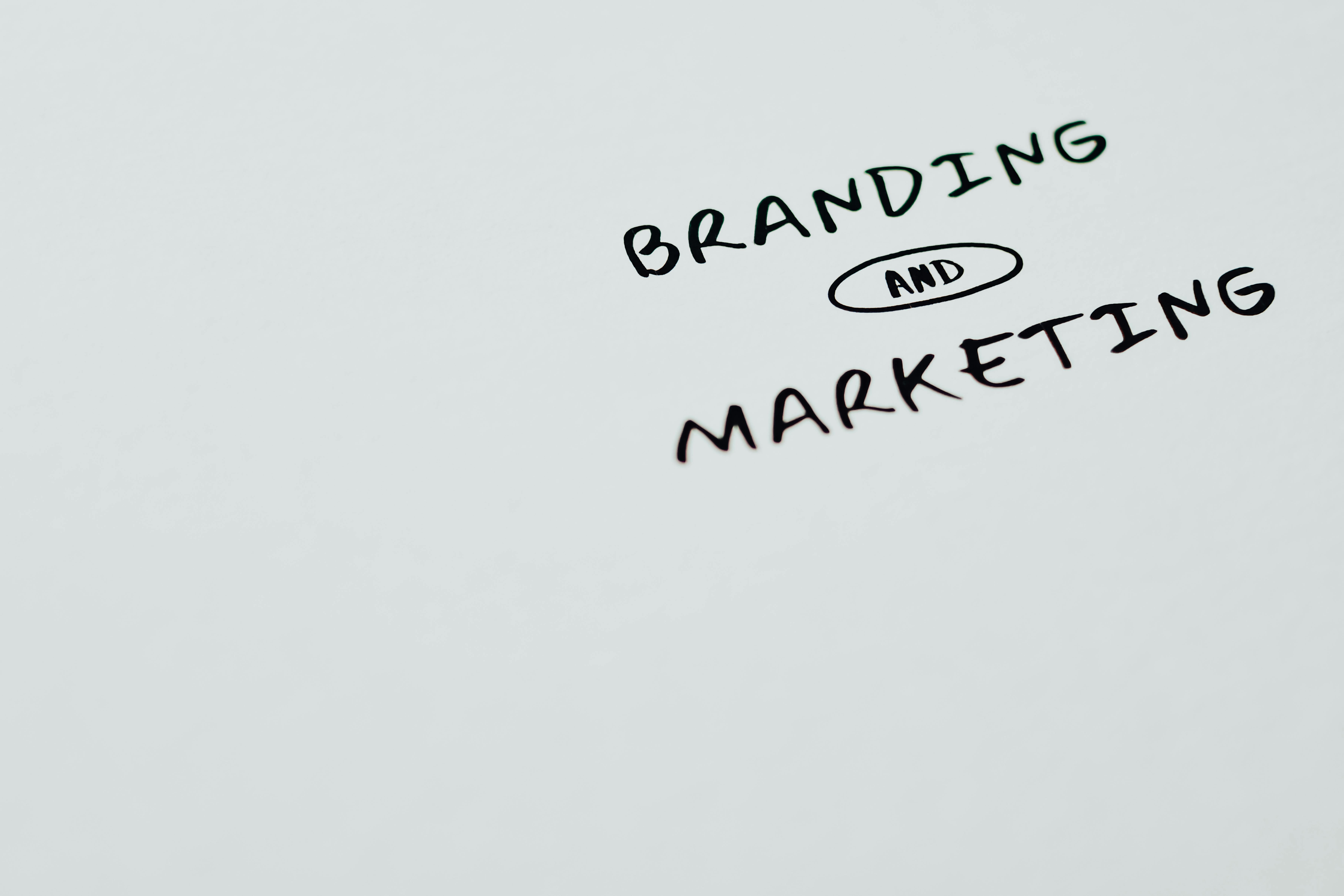 Branding and Marketing Text on a White Surface · Free Stock Photo
