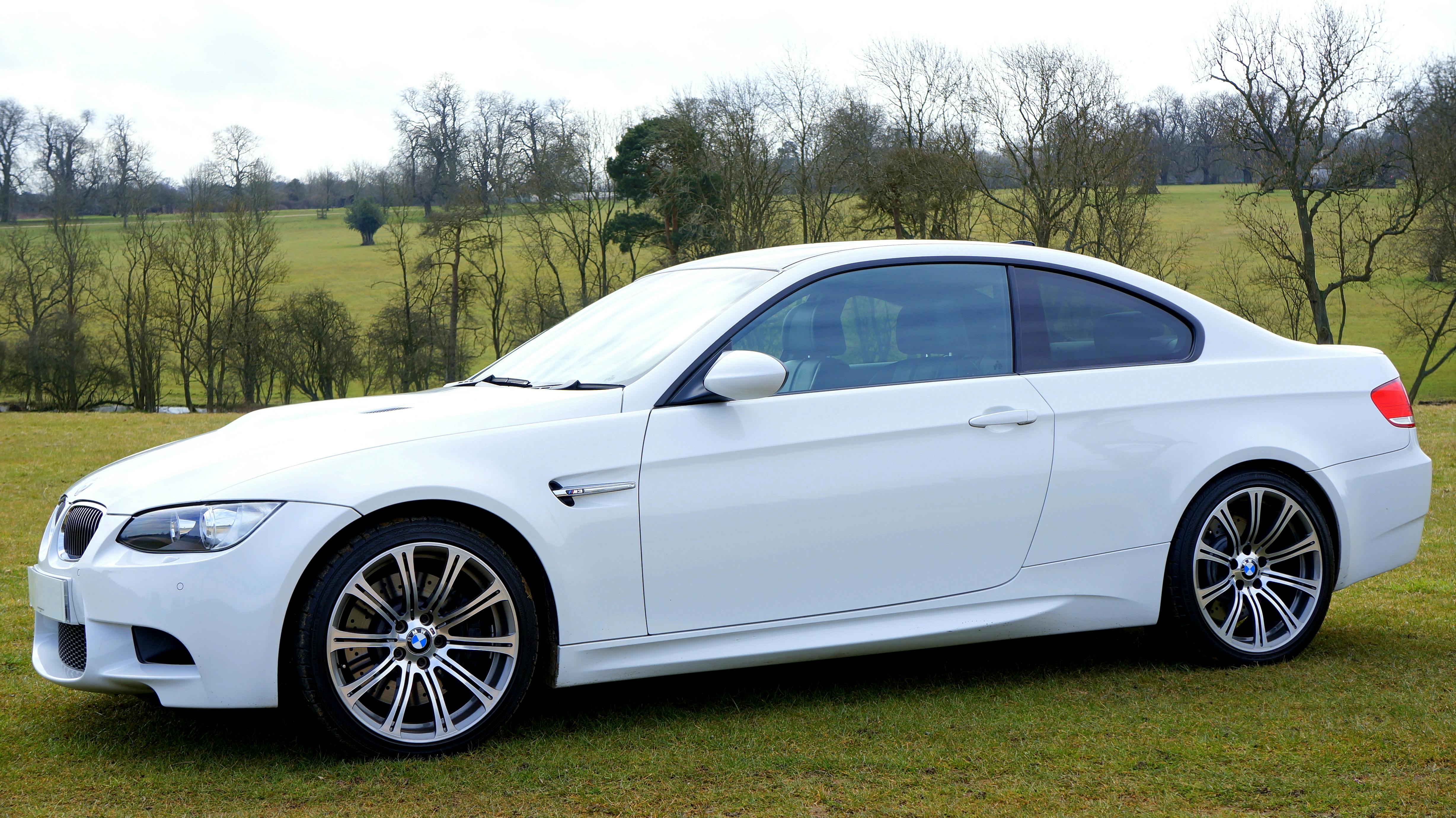 A White Car Parked on a Grass · Free Stock Photo
