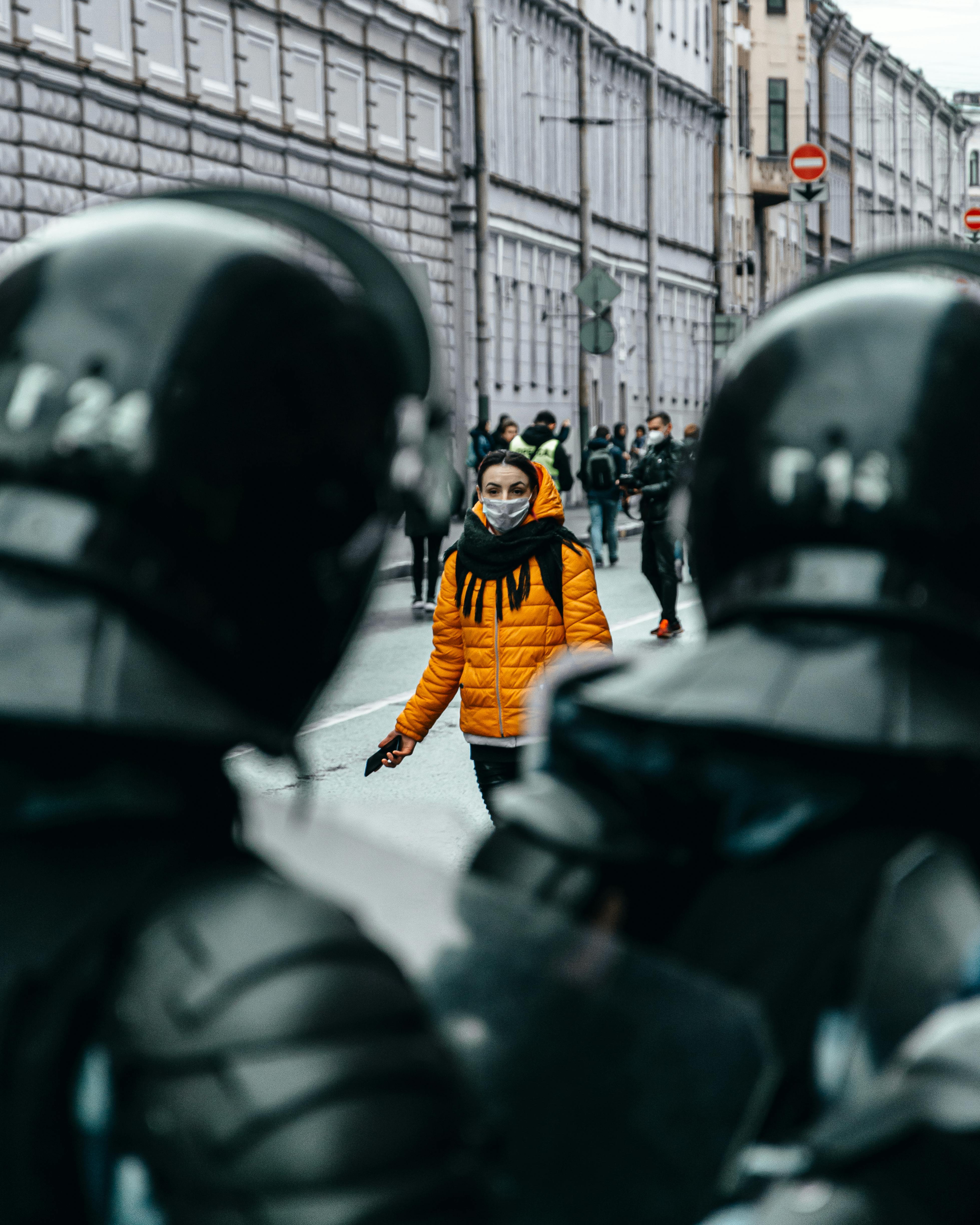 Woman behind Helmets of Police Officers · Free Stock Photo
