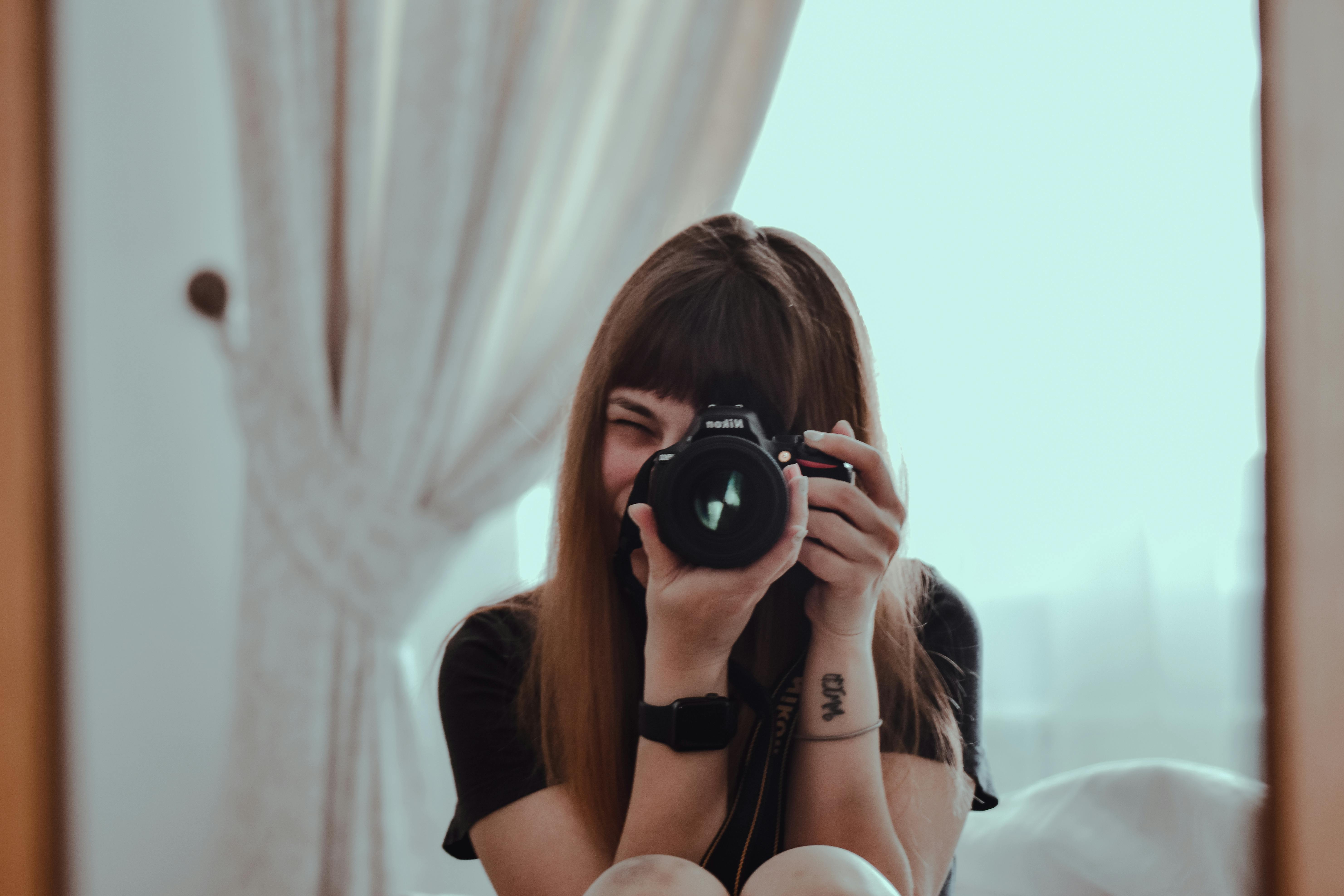 A Person Taking Photo Using a DSLR Camera · Free Stock Photo