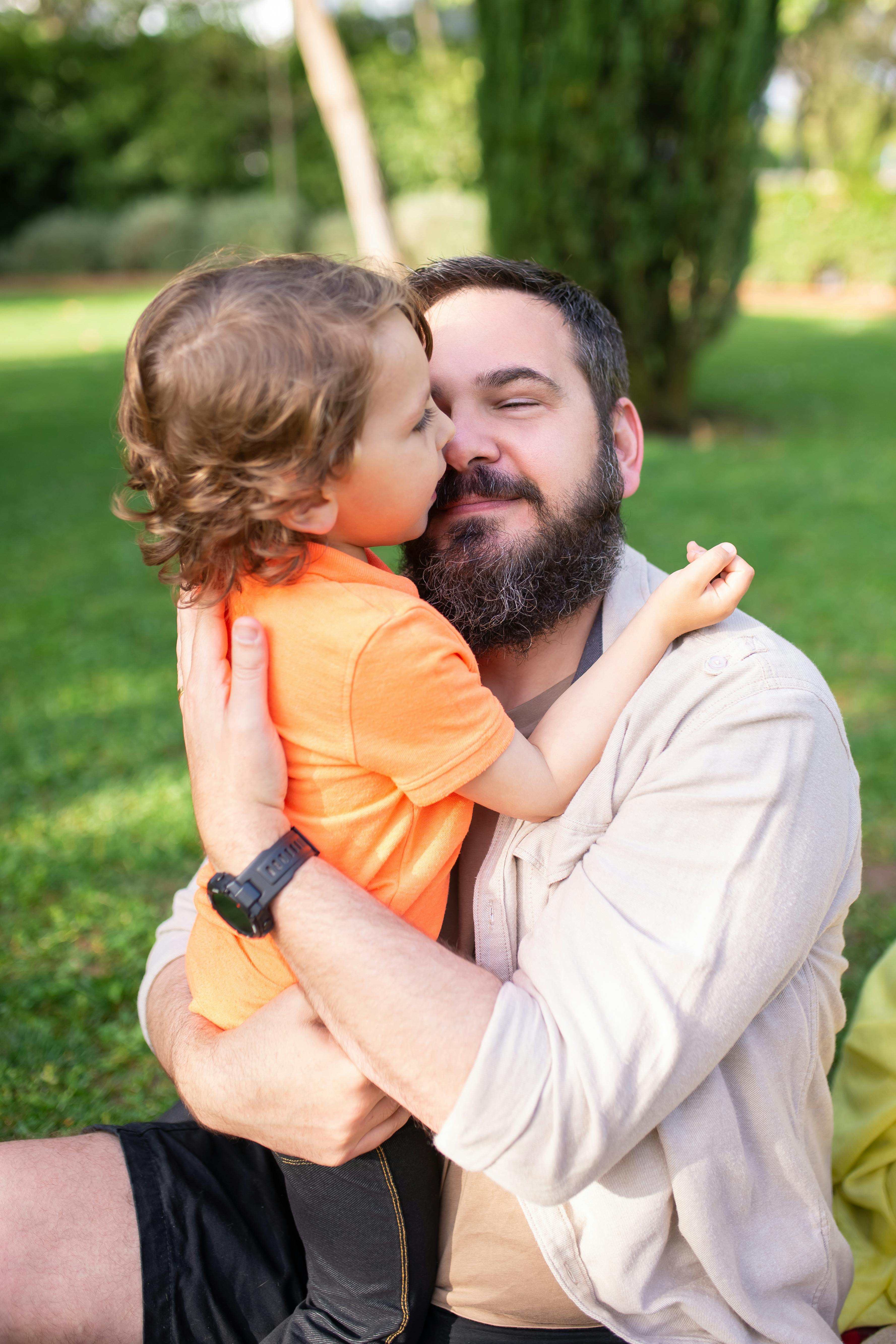 Bearded Man Hugging a Boy · Free Stock Photo