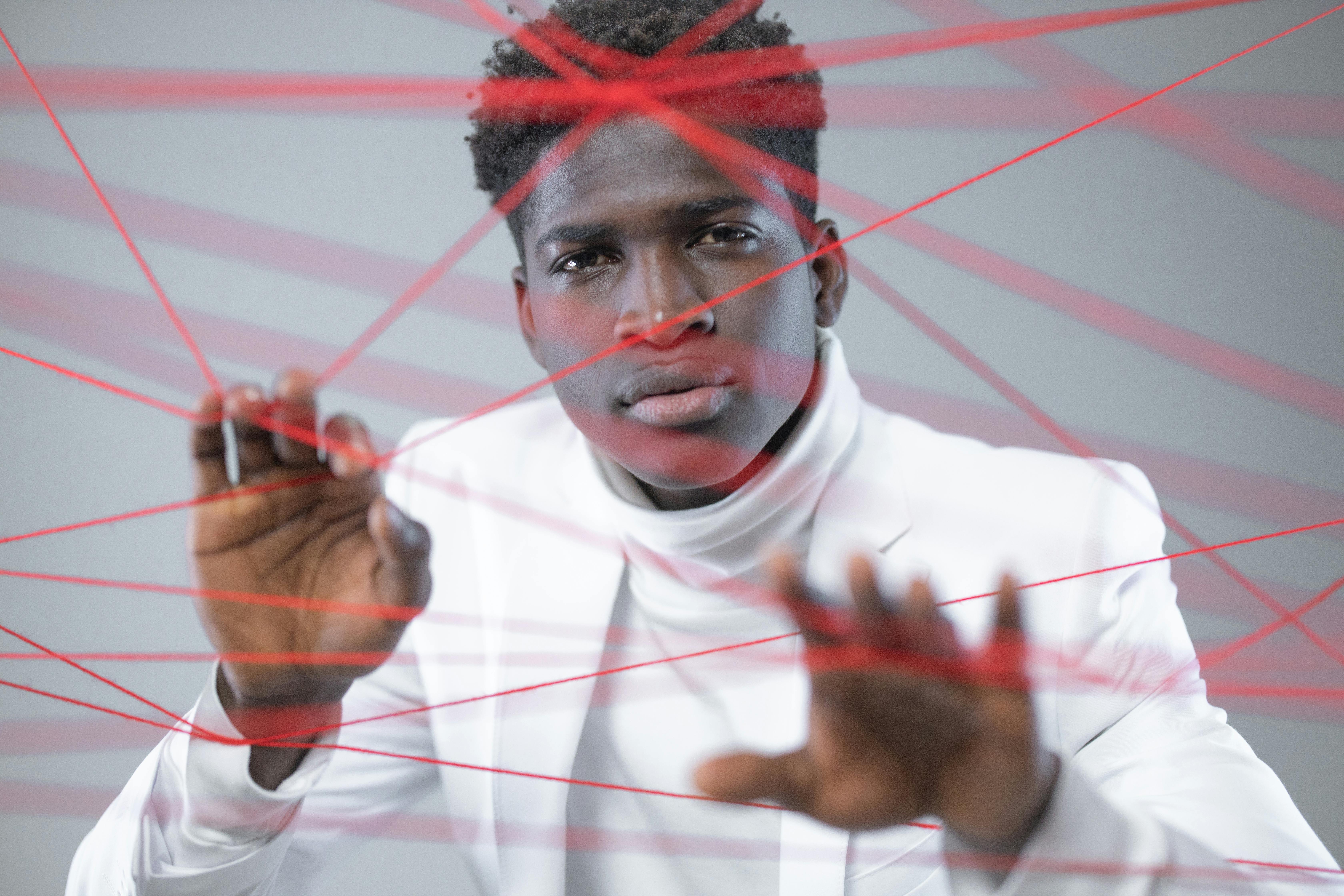 A Man Behind a Red Thread · Free Stock Photo