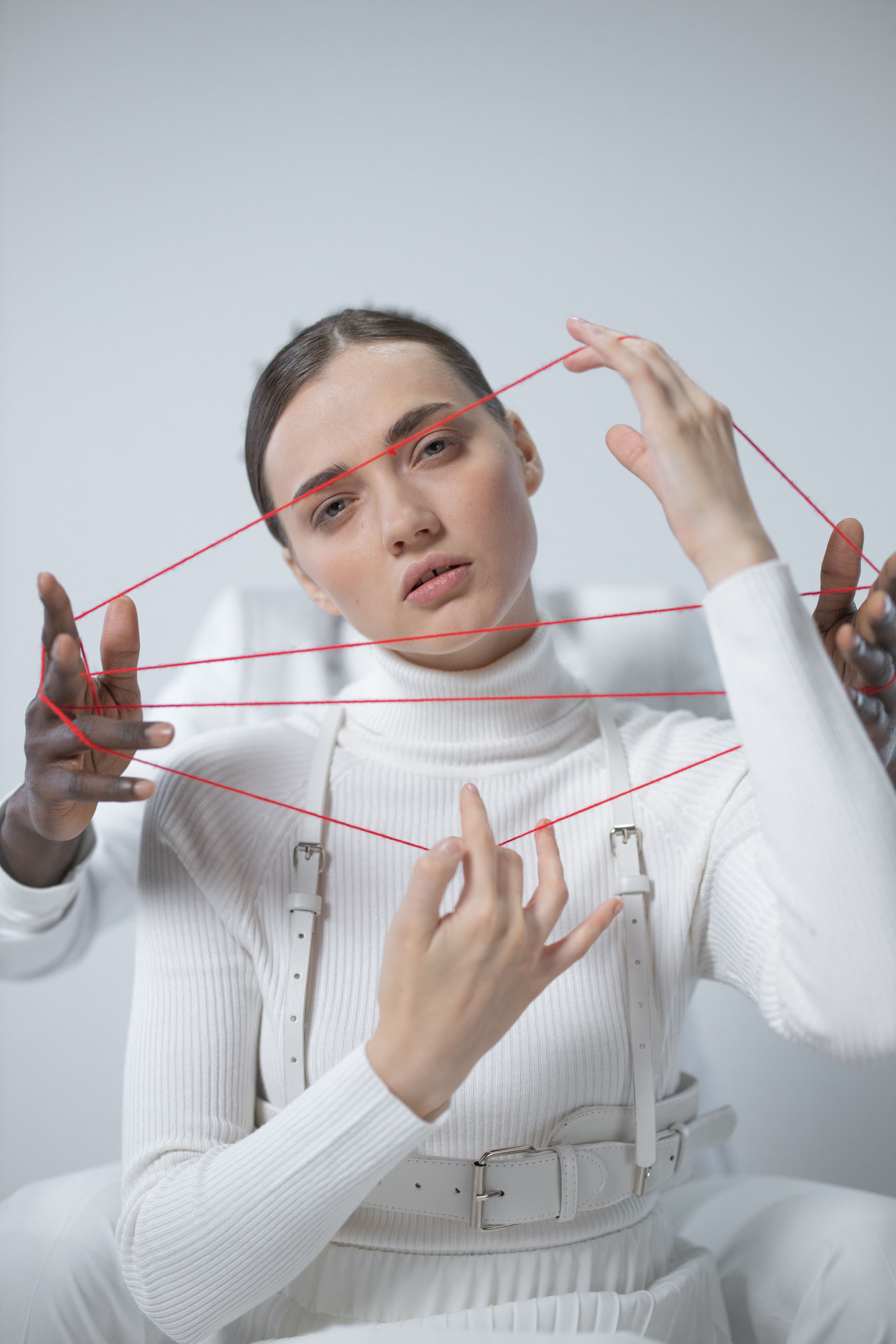 A Portrait of a Woman Doing a String Figure with a Person · Free Stock ...