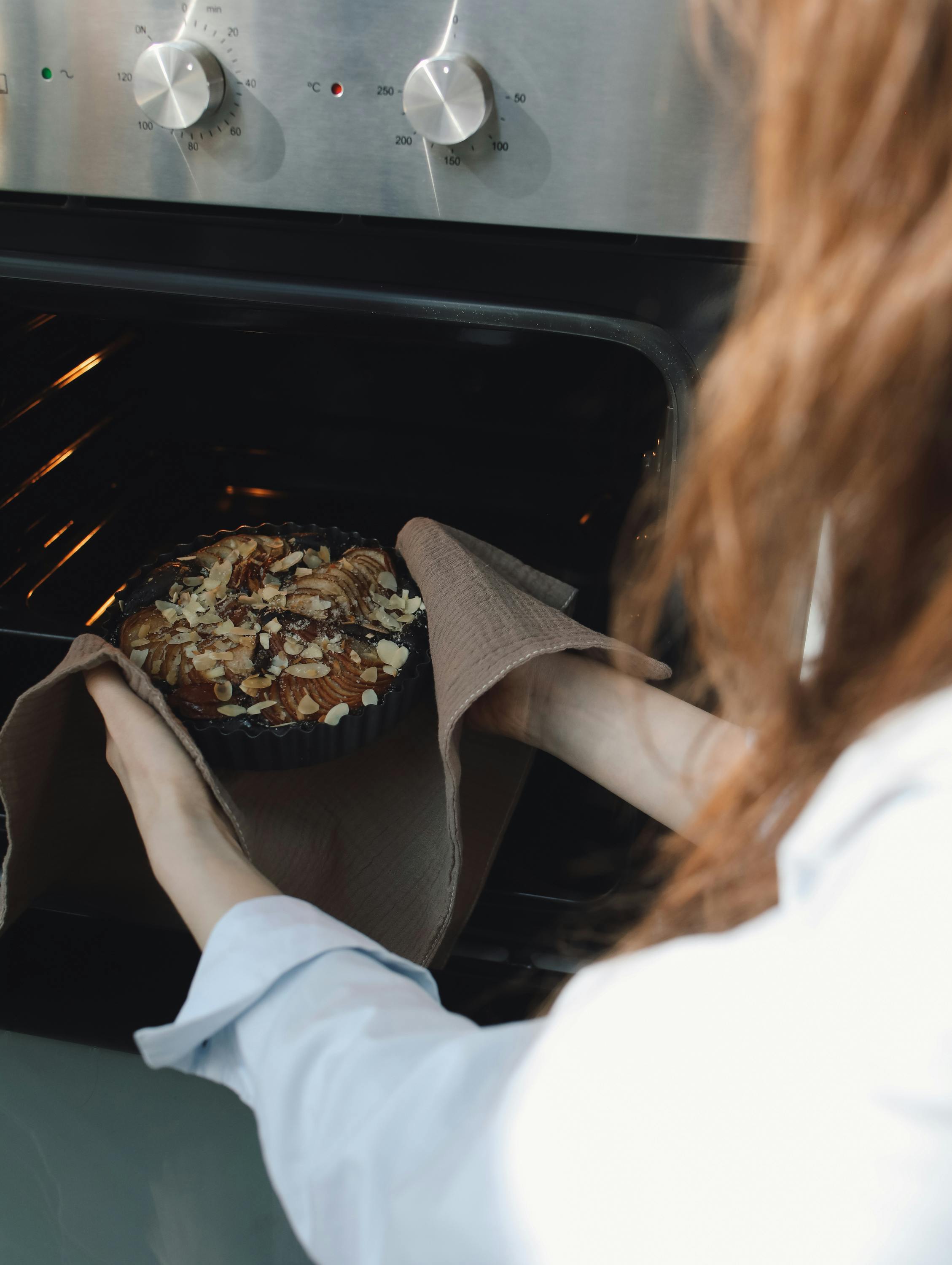 Woman Putting Food into Oven · Free Stock Photo