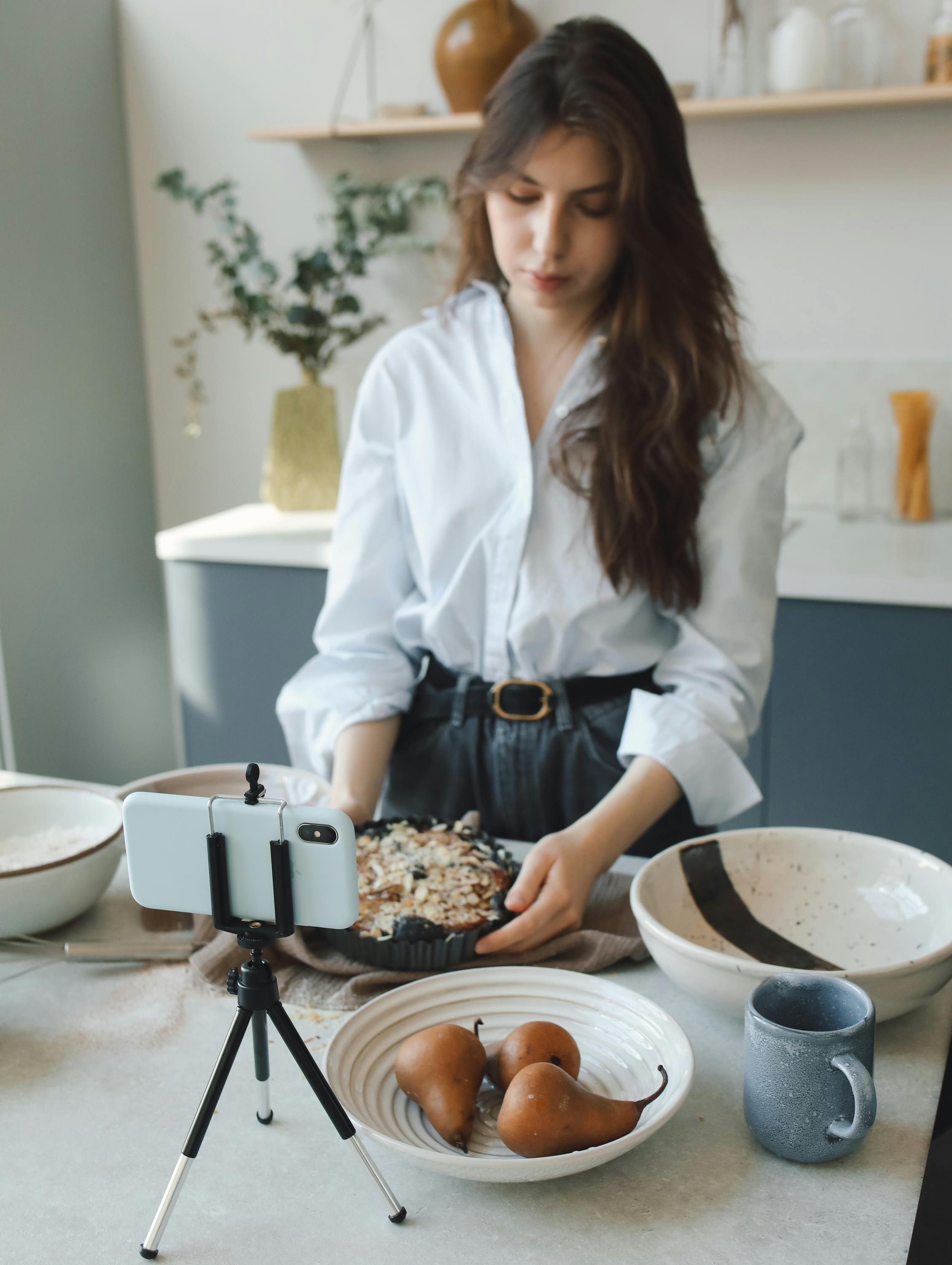 Woman in White Blazer Cooking while Vlogging · Free Stock Photo