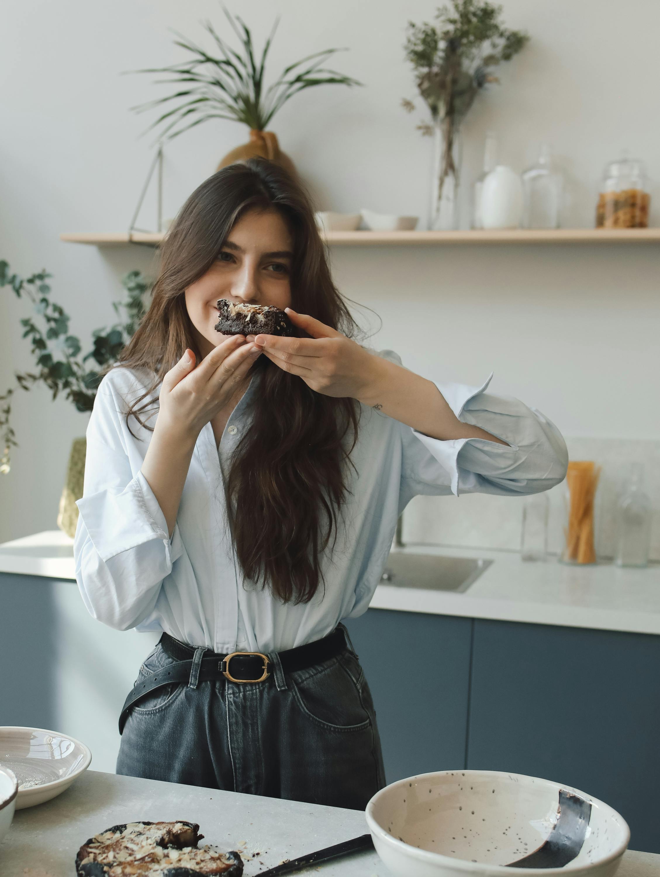 Woman Smelling Sliced Chocolate Cake · Free Stock Photo
