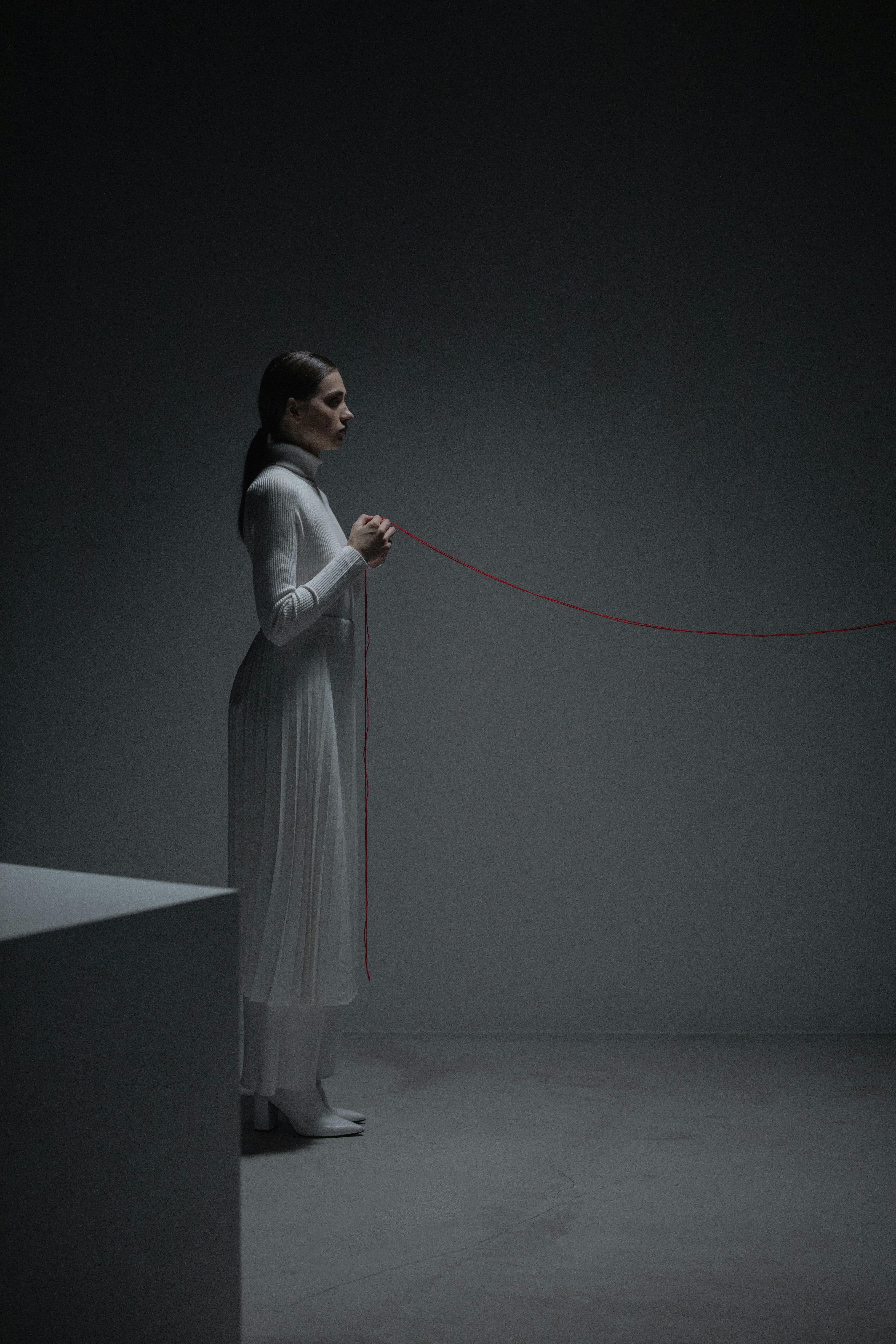 Man in White Dress Holding a Red String · Free Stock Photo