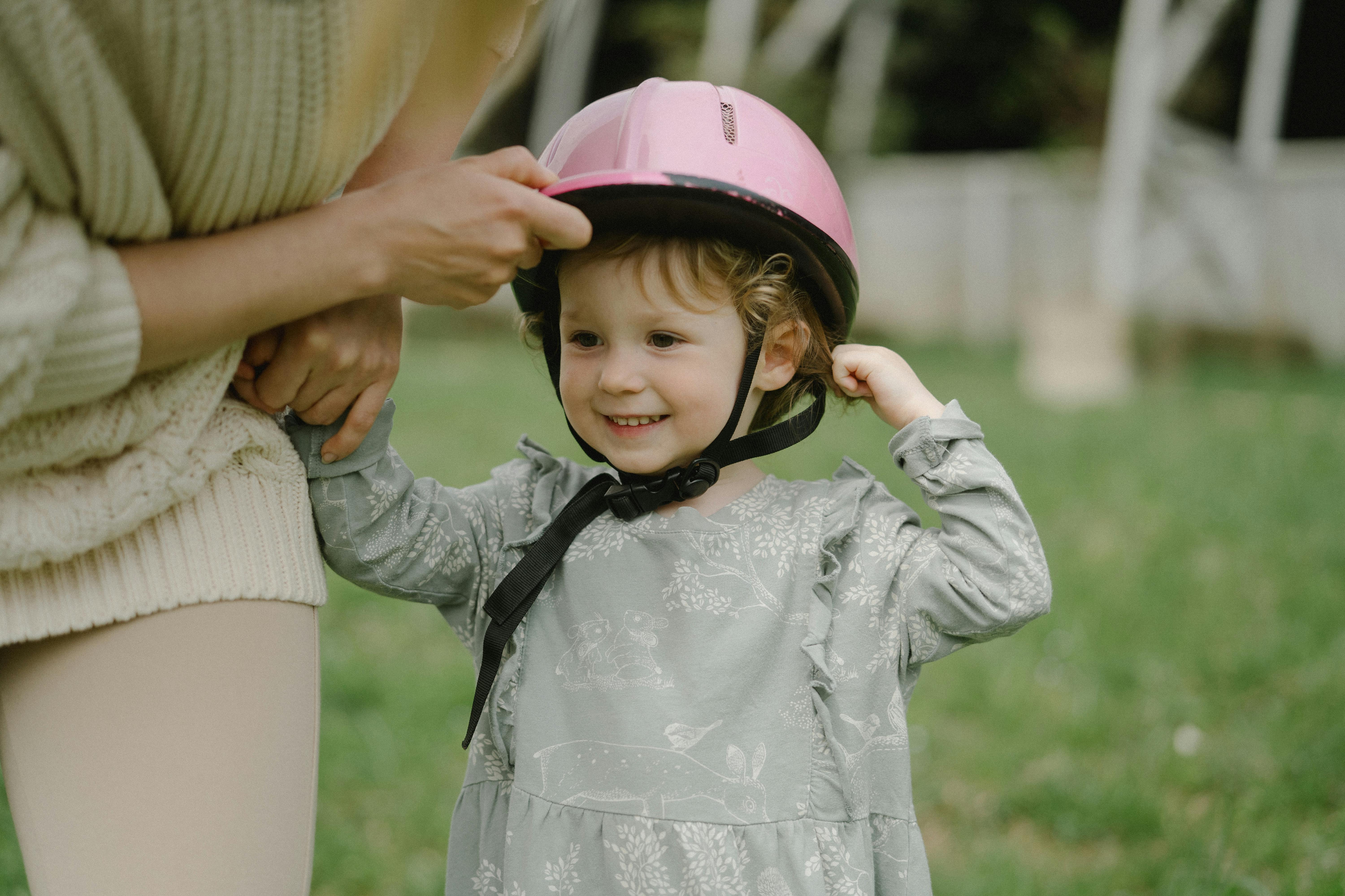 A Girl Wearing a Pink Helmet · Free Stock Photo