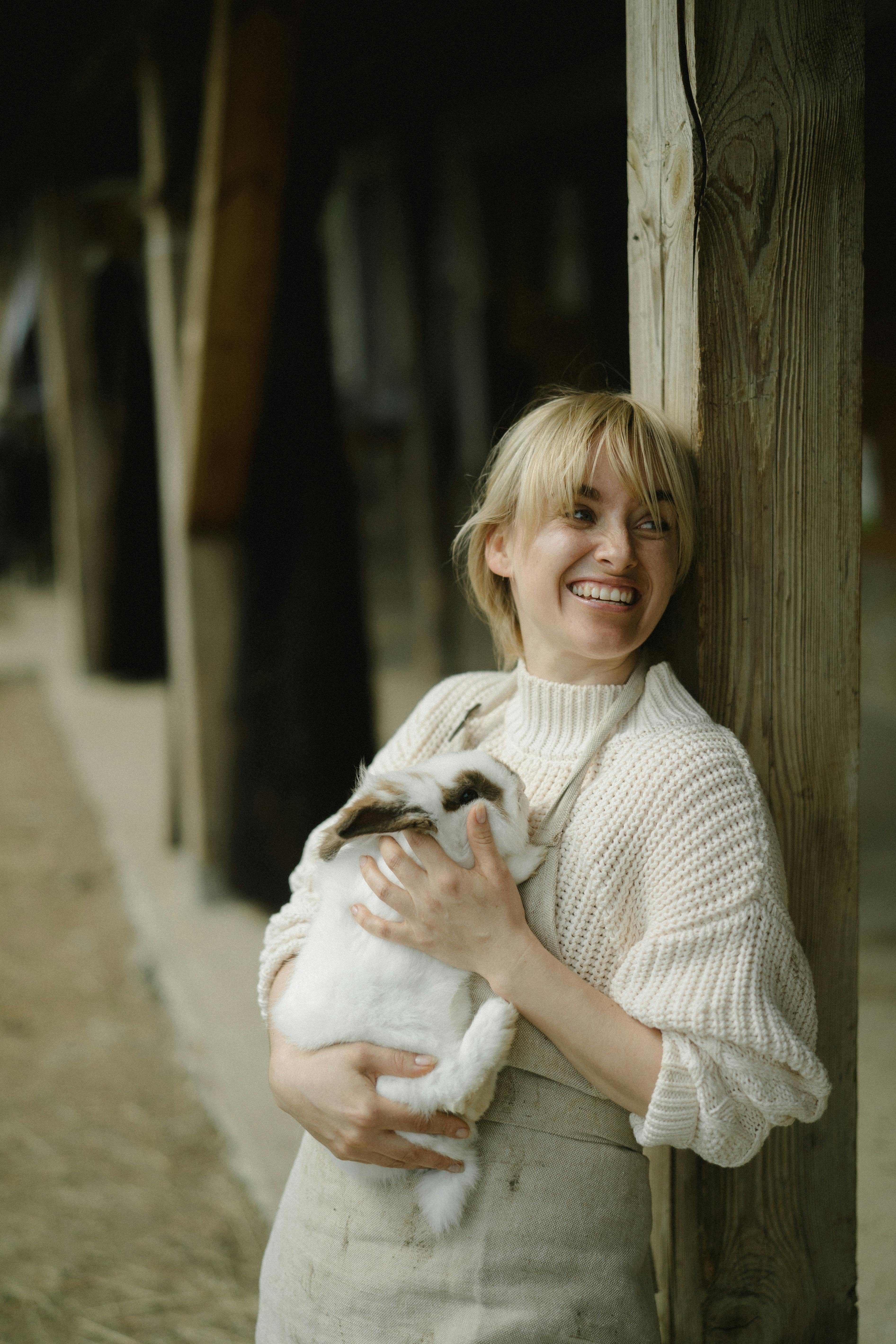 A Woman Carrying a Rabbit · Free Stock Photo