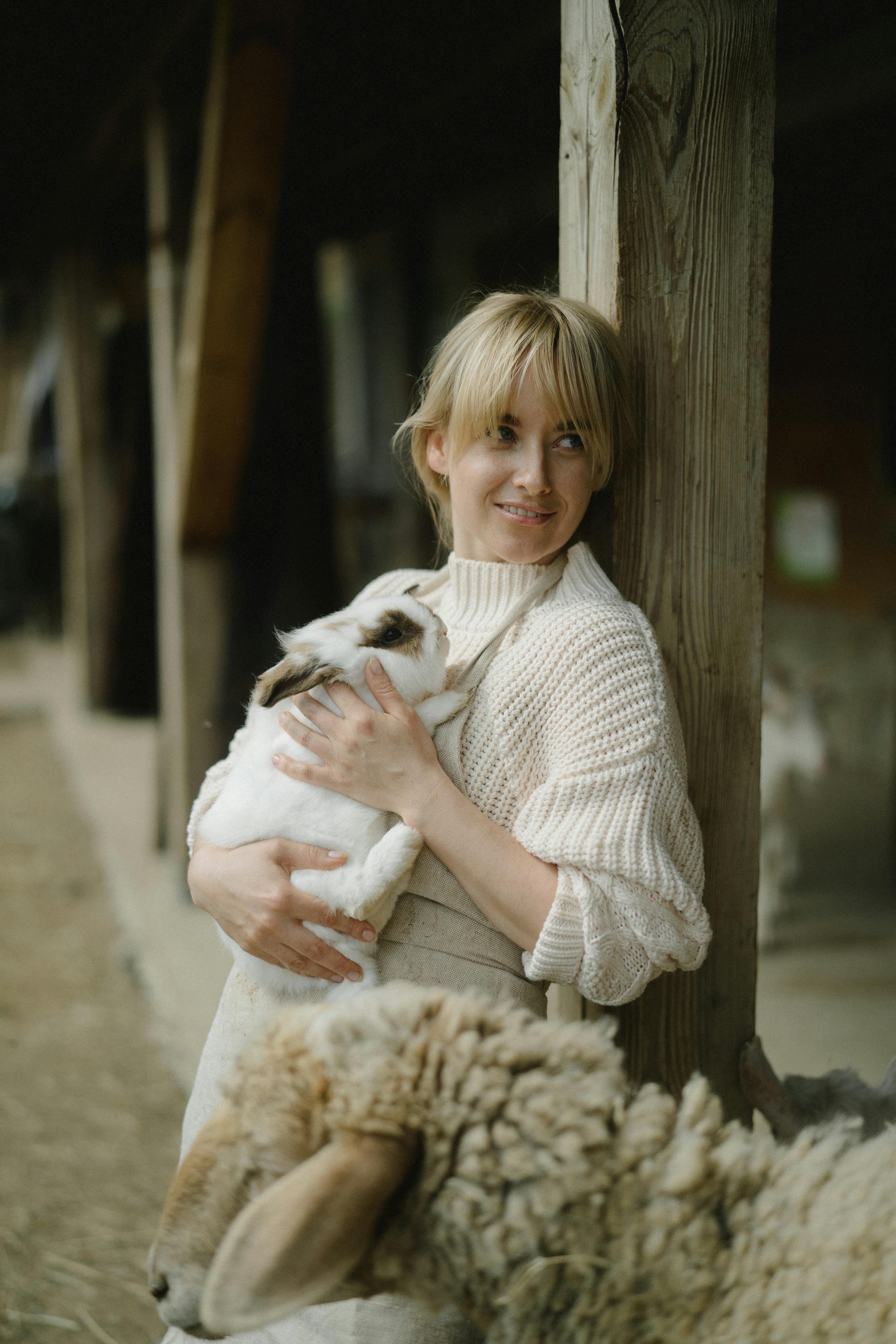 A Woman Carrying a Rabbit · Free Stock Photo