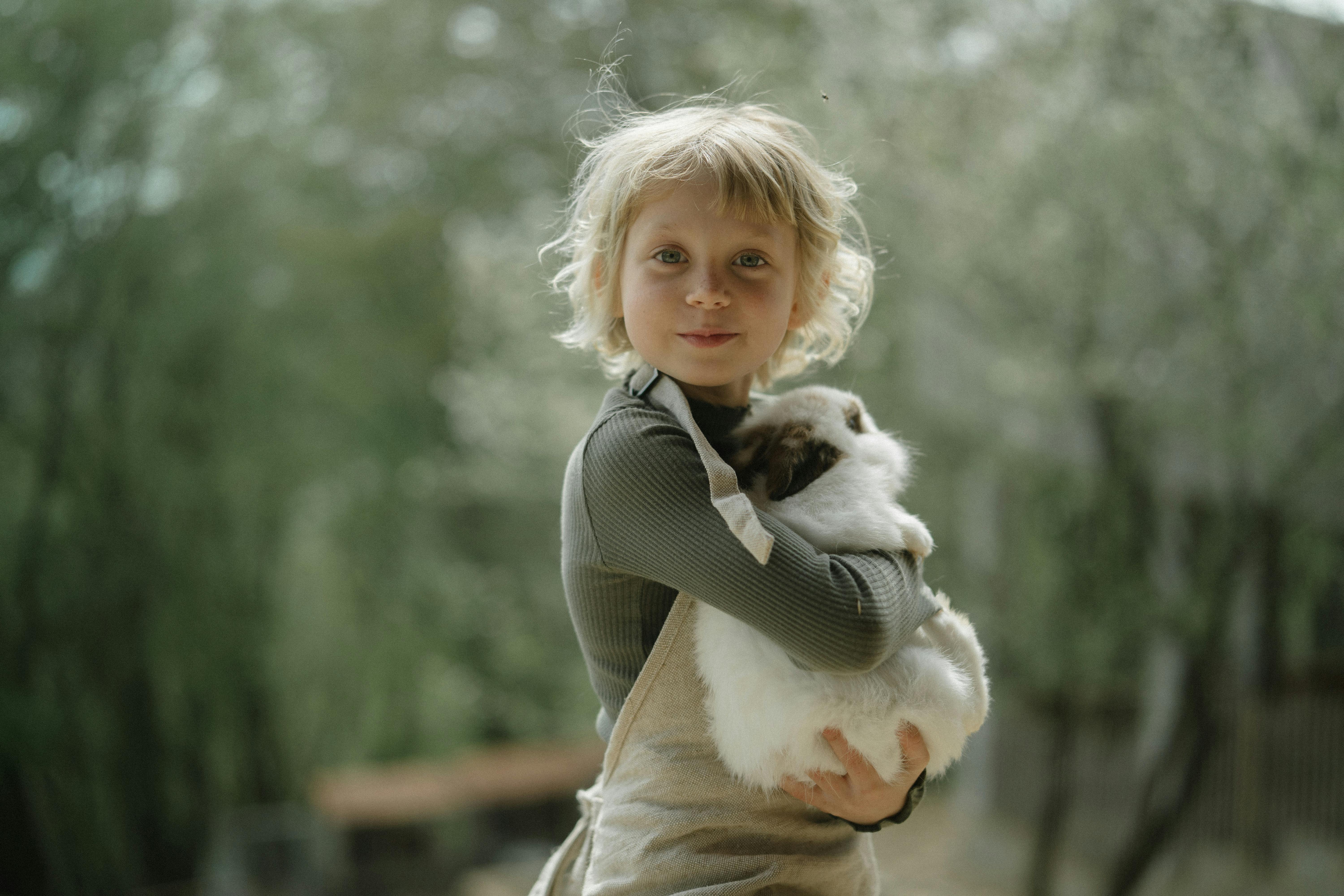 Child Carrying a Rabbit · Free Stock Photo