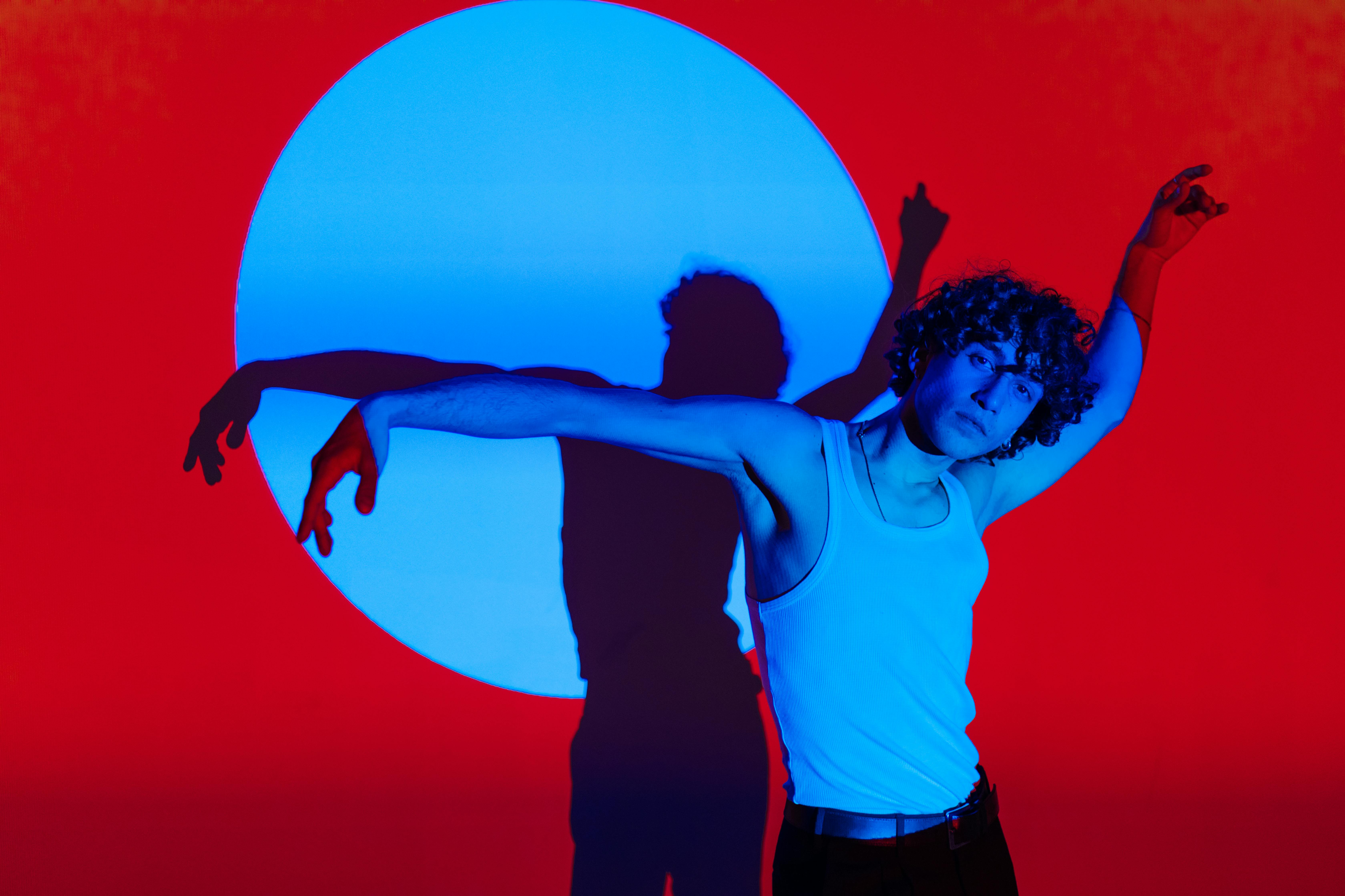 Man Dancing With Blue Light Reflection · Free Stock Photo