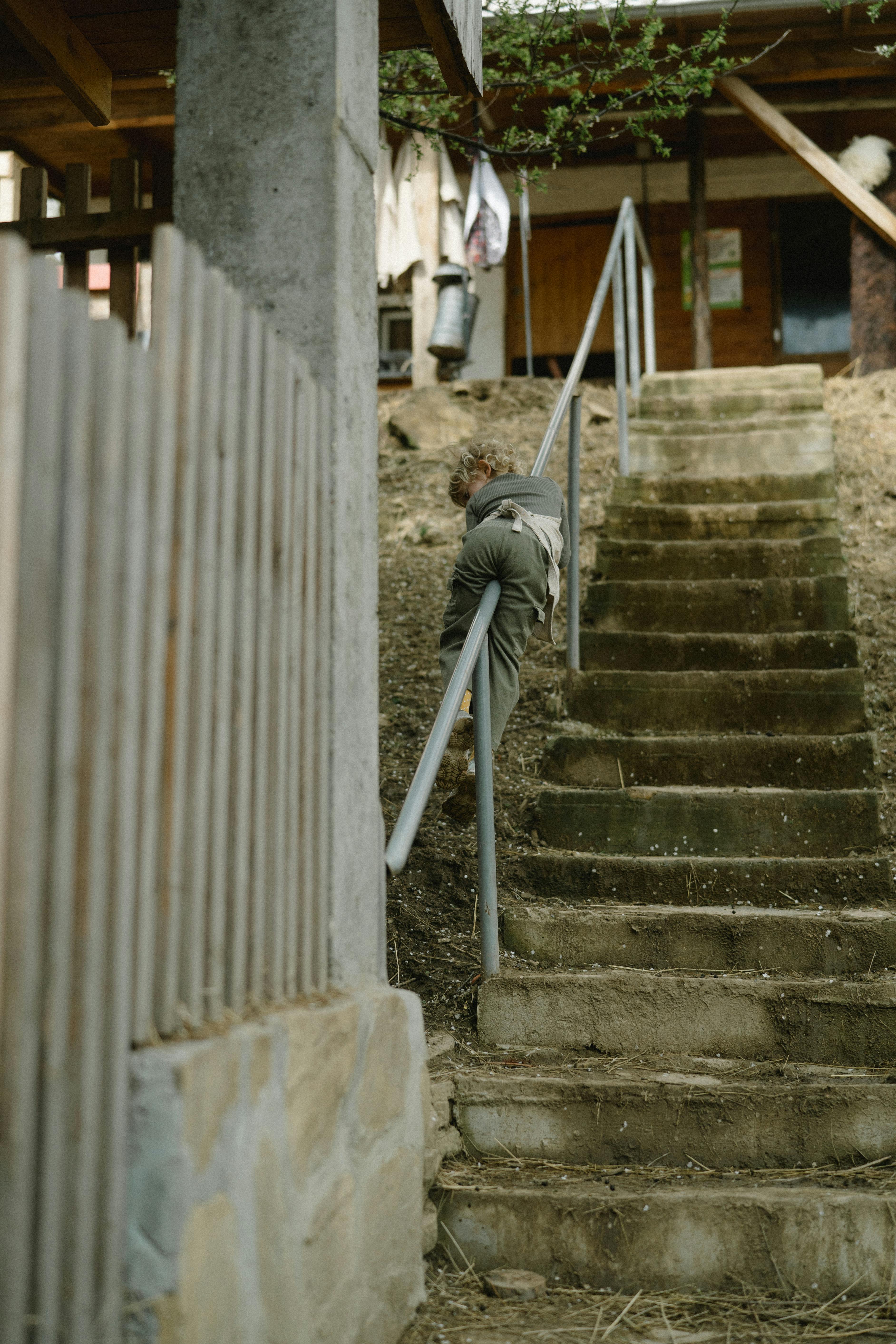 A Kid Sliding Down on a Handrail · Free Stock Photo