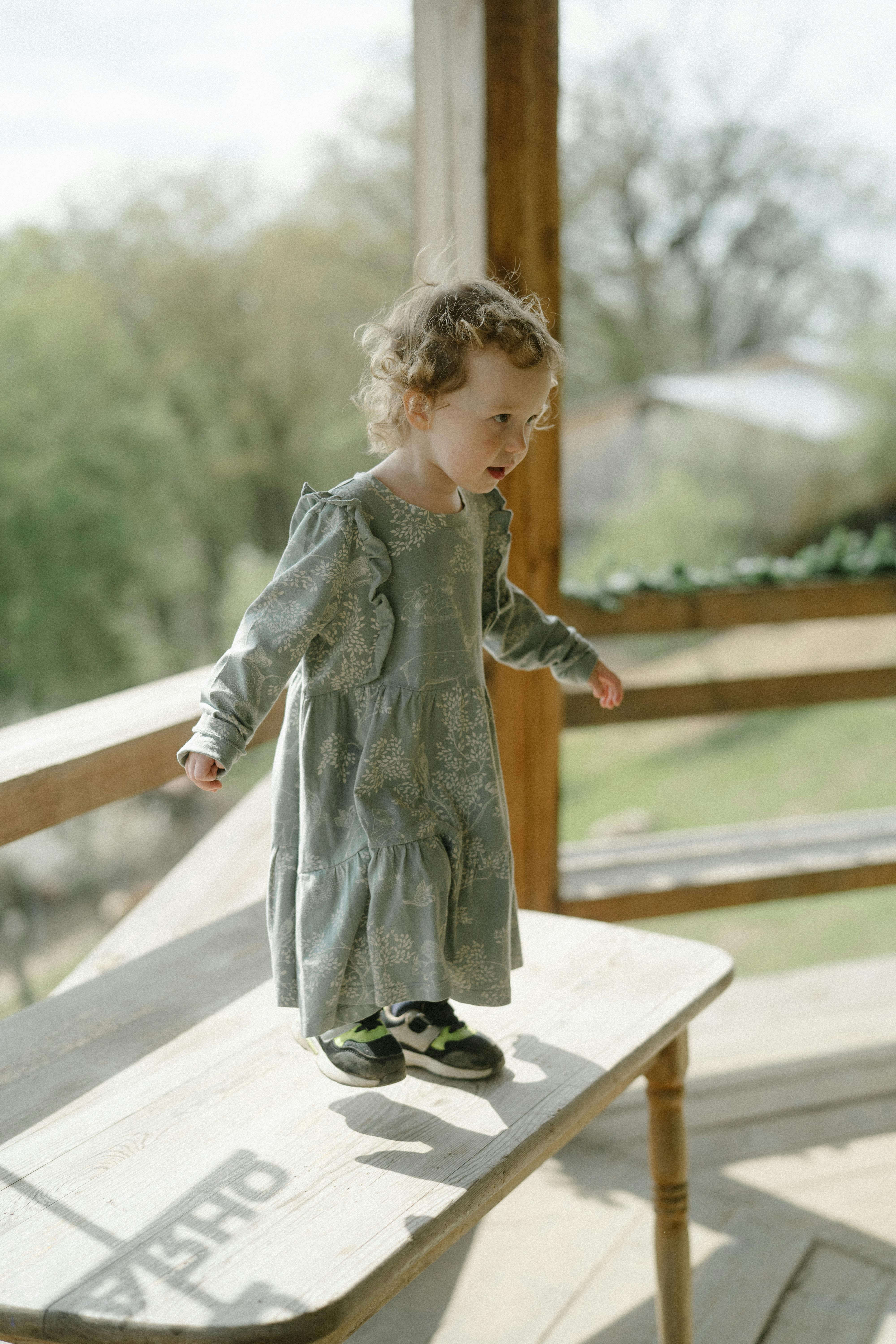 Girl in Green Dress Standing on a Table · Free Stock Photo