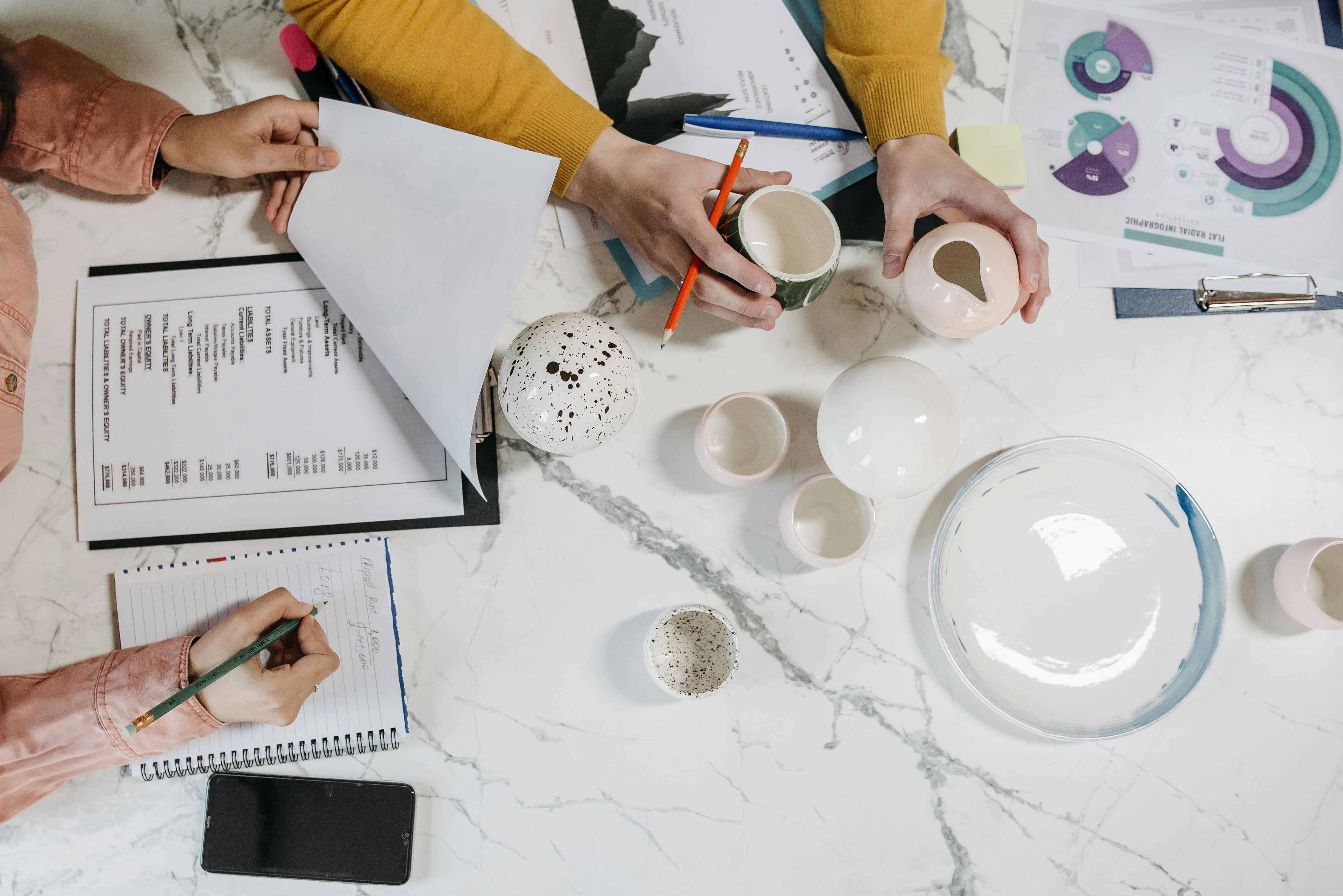 People Holding Ceramic Objects · Free Stock Photo