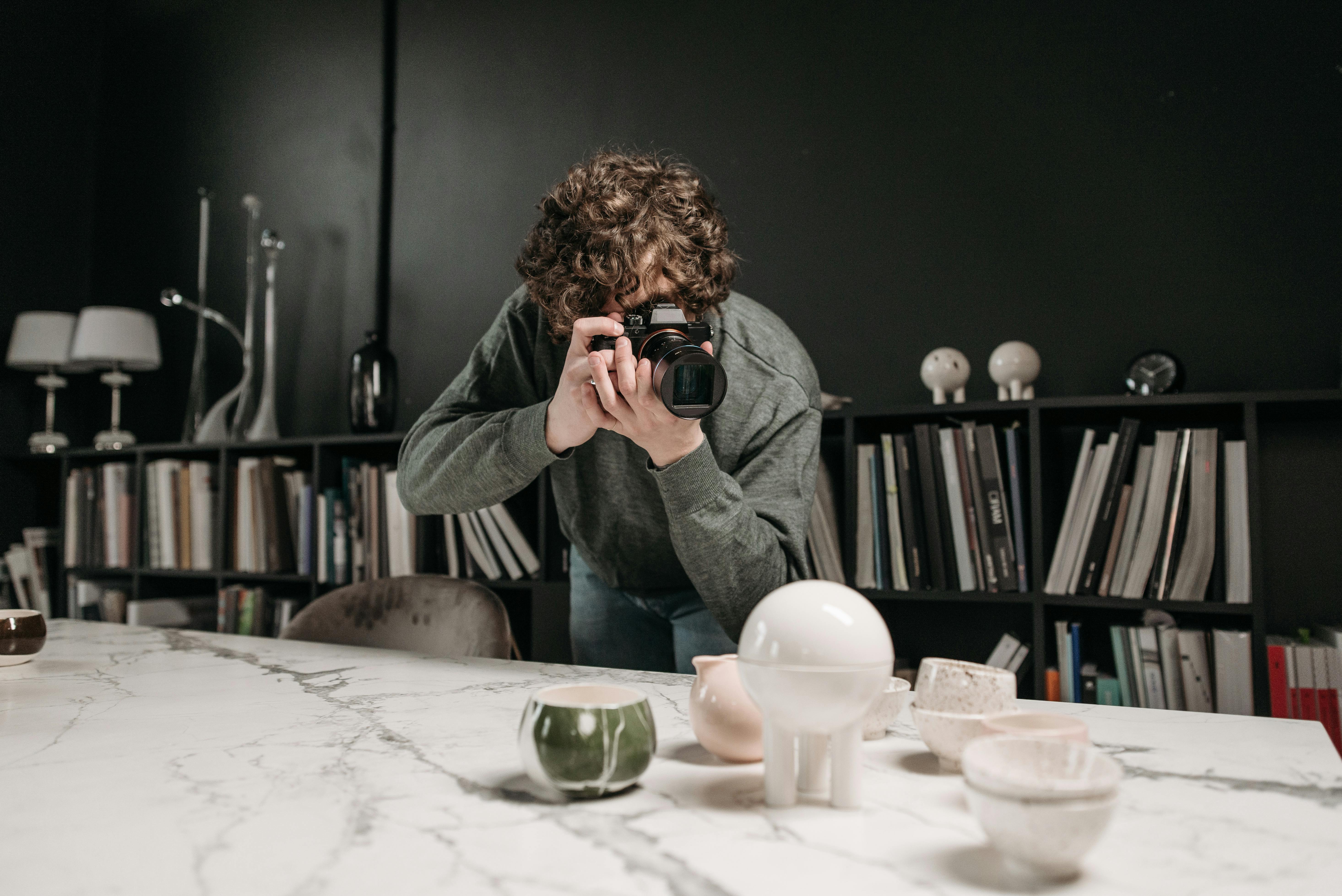 A Photographer Taking Photo of Ceramic Products · Free Stock Photo