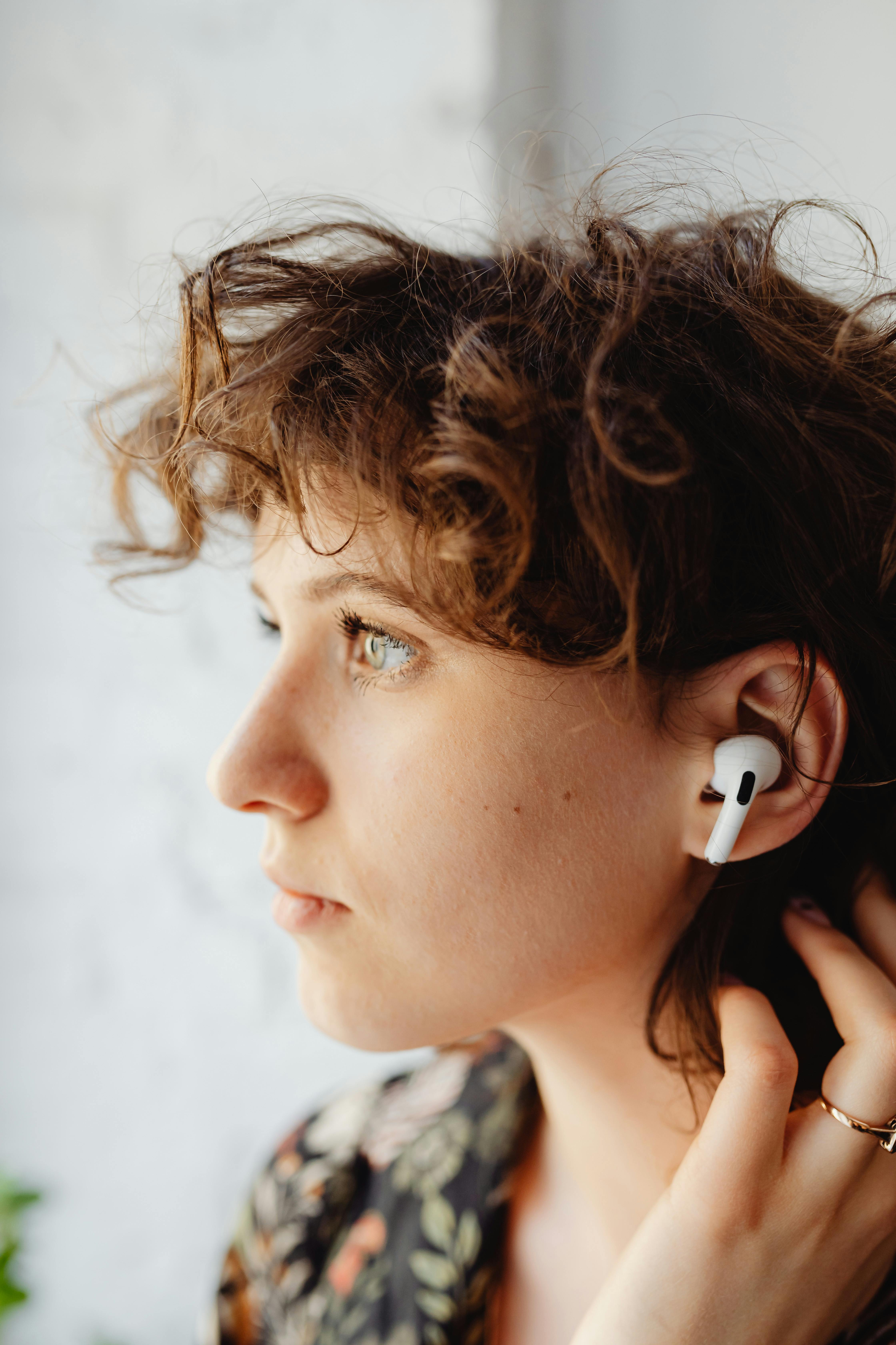 A Woman Wearing a Wireless Earphone · Free Stock Photo