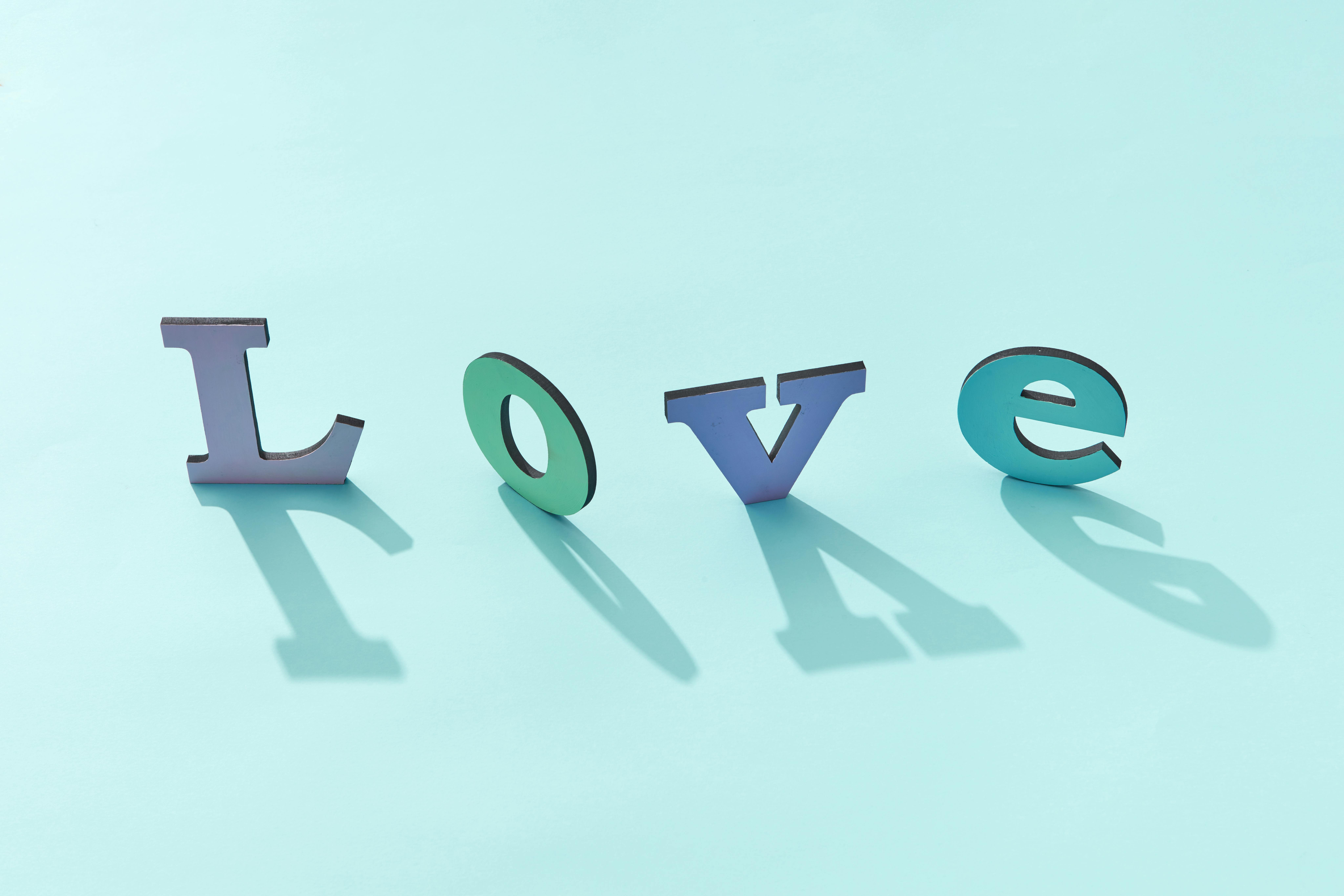 Love Cut Outs on Blue Surface · Free Stock Photo