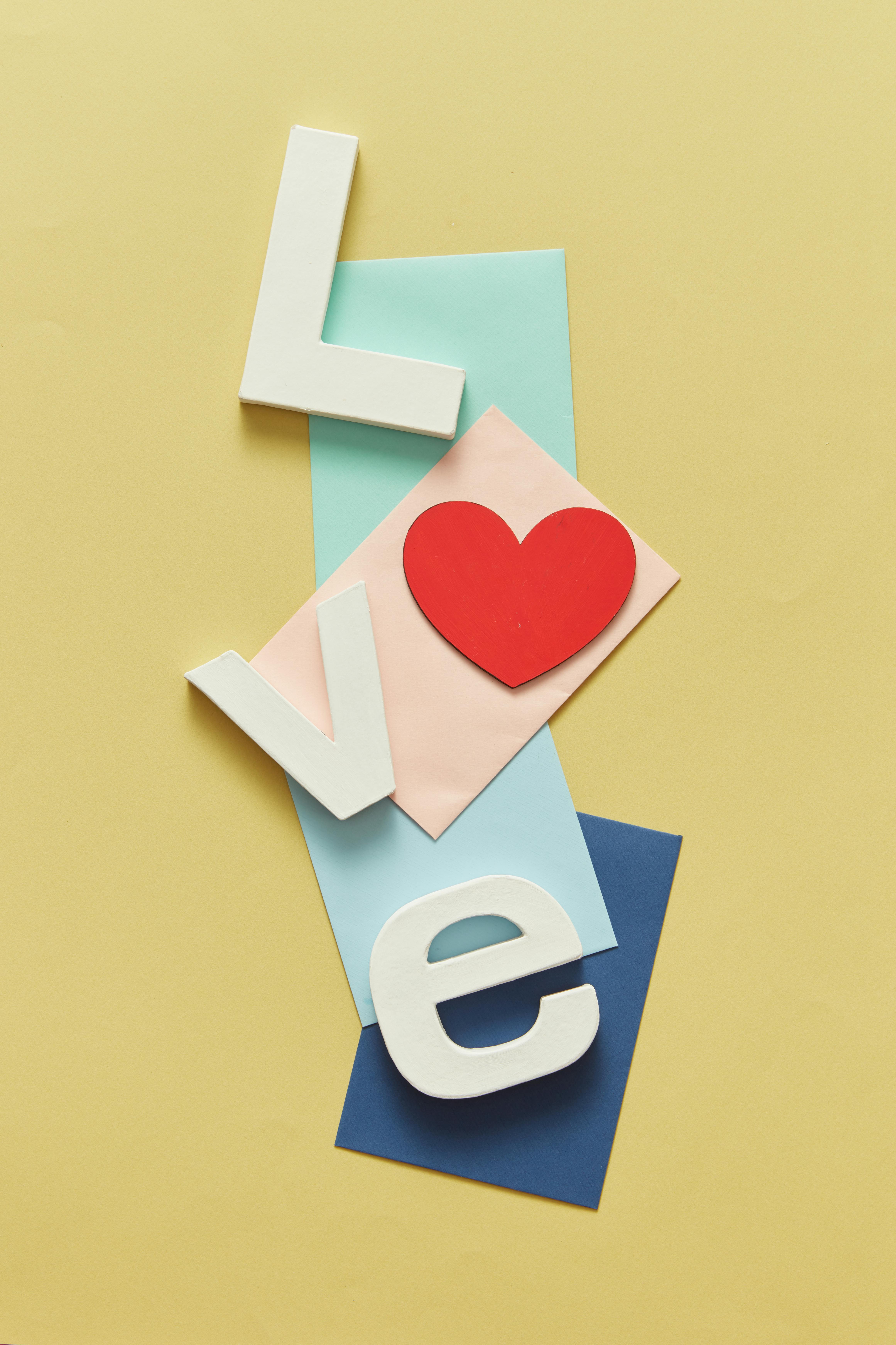 Love Cut Outs on Beige Surface · Free Stock Photo