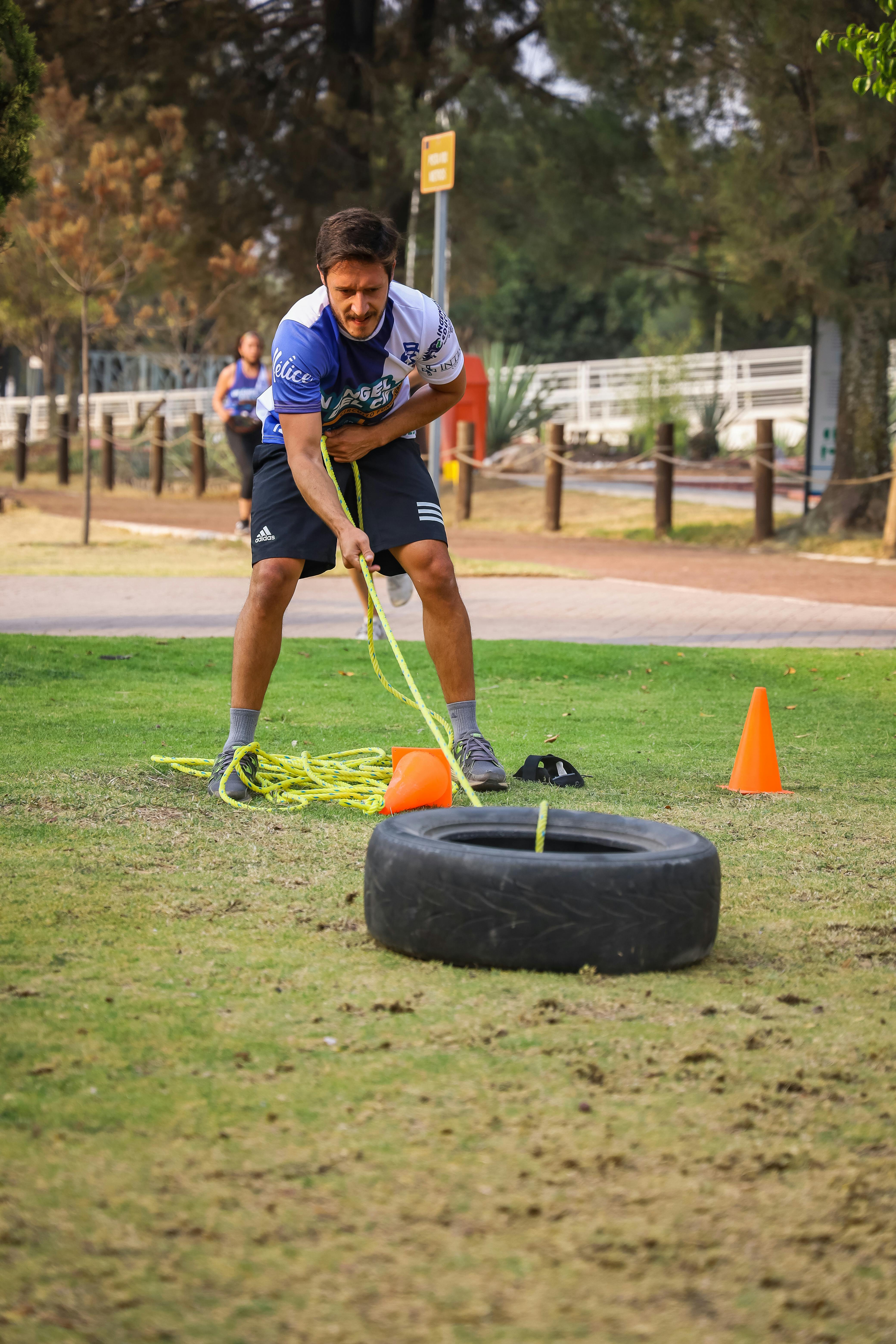 A Man Pulling a Tire · Free Stock Photo