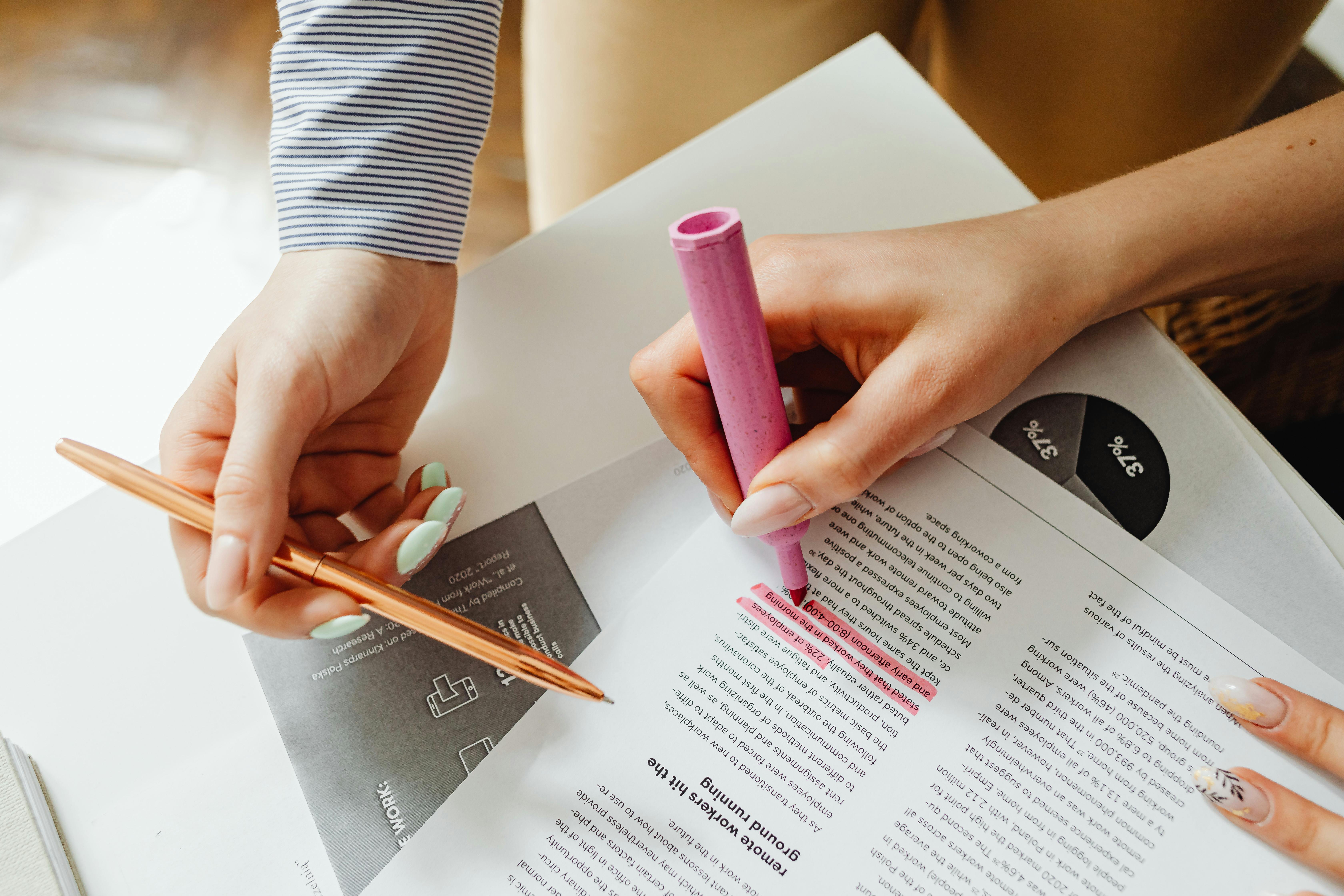 Close-Up Photo of a Person Using a Pink Highlighter · Free Stock Photo