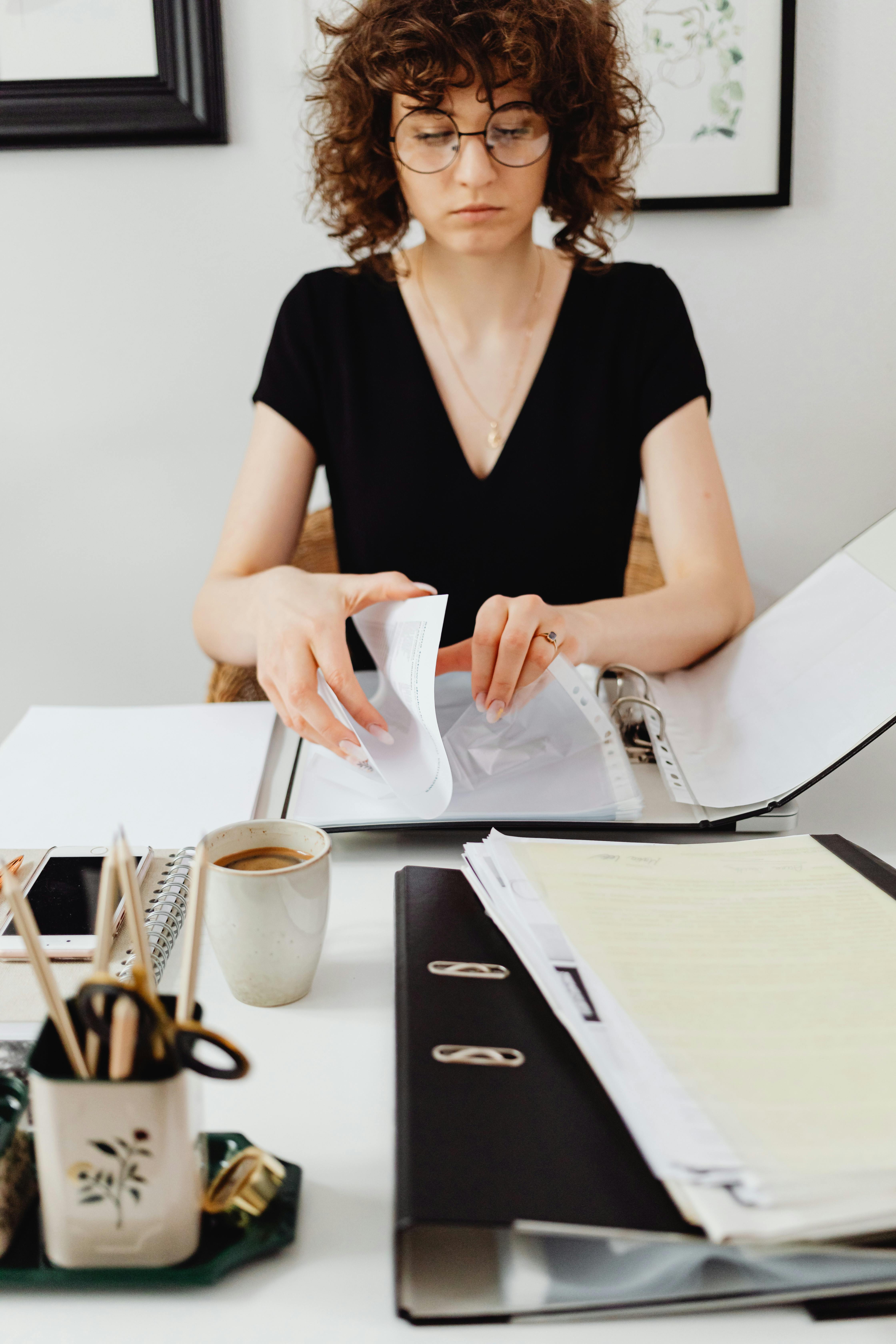 Woman Sorting Documents at Work · Free Stock Photo