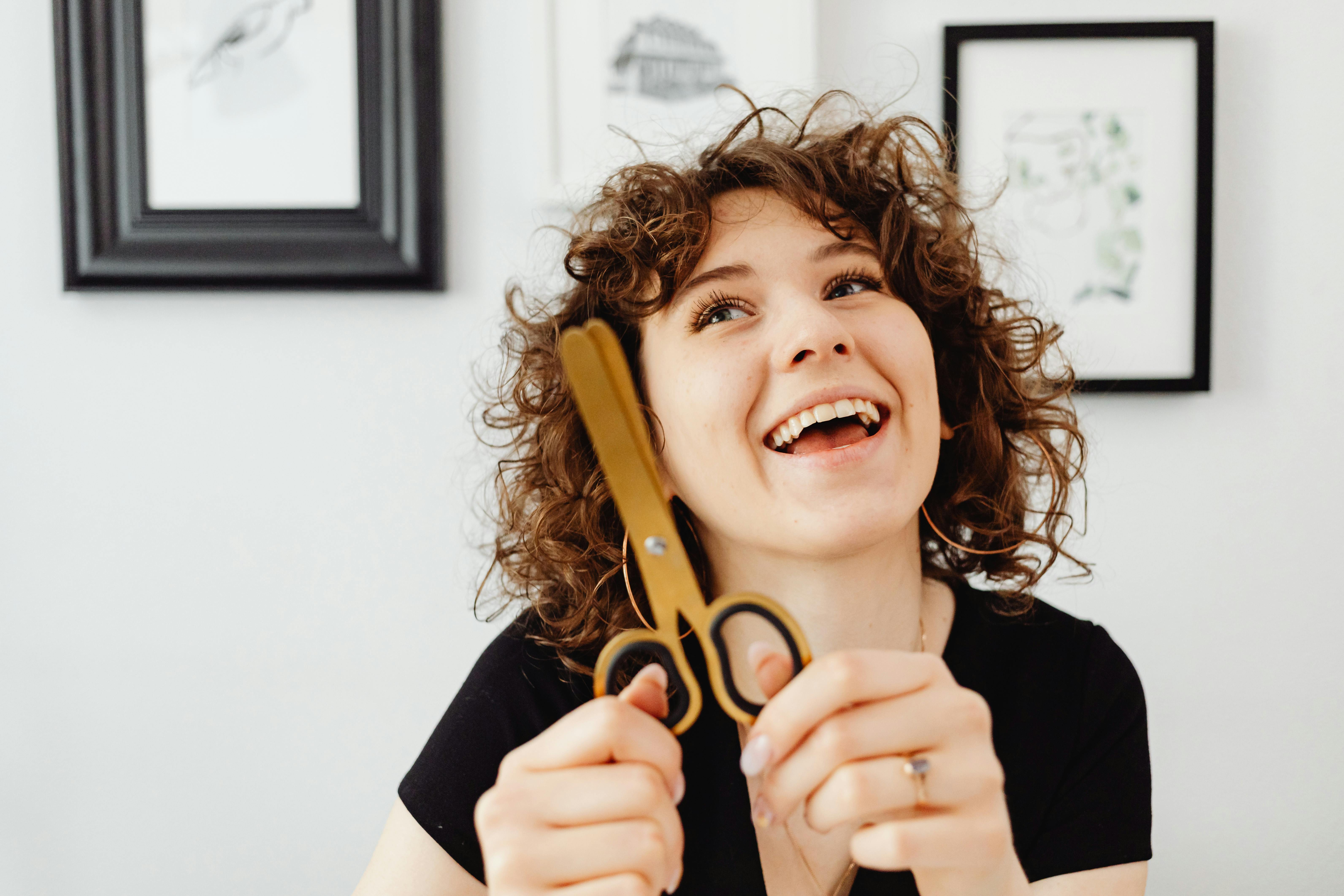 Pretty Woman Holding a Scissor · Free Stock Photo