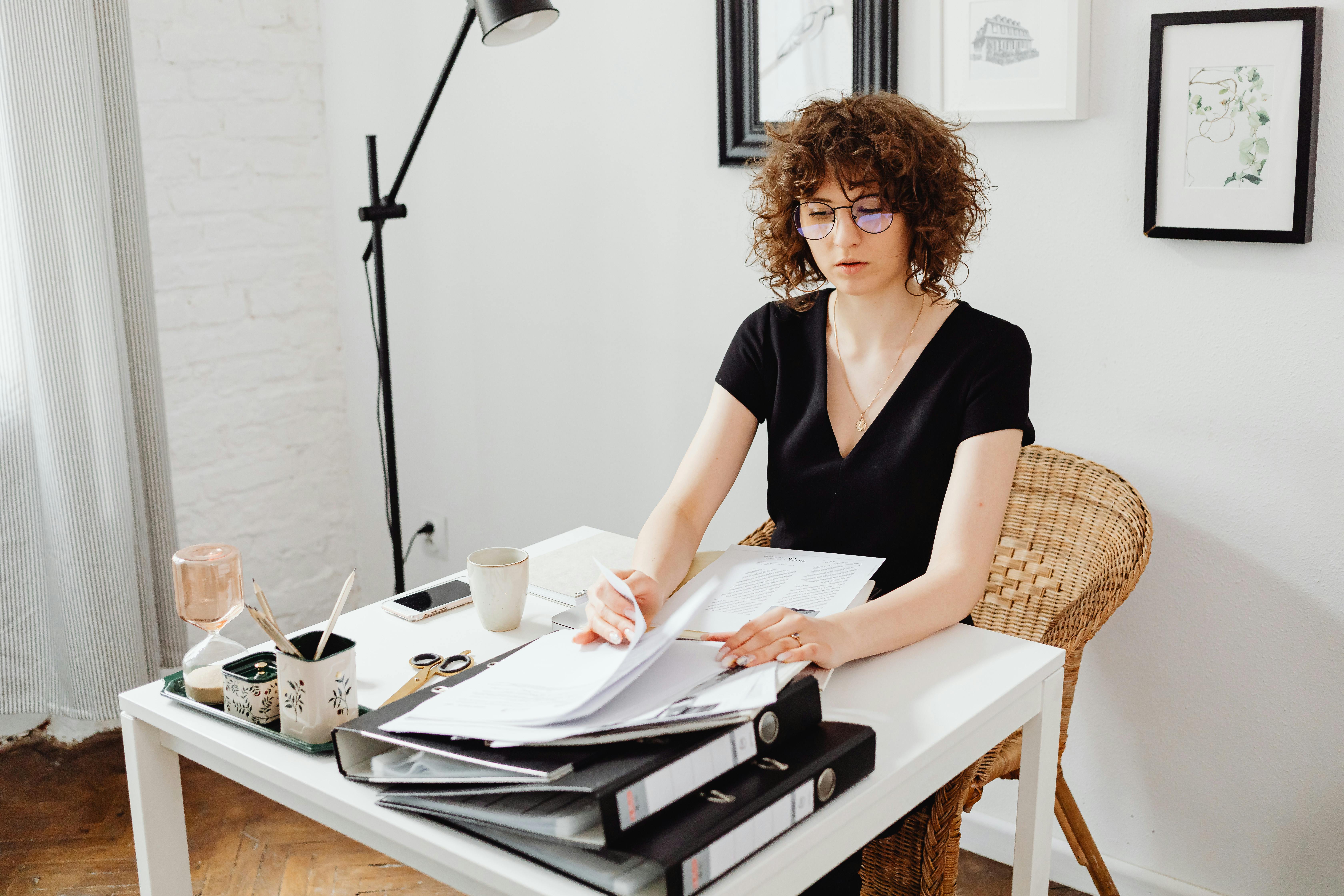 Woman Sitting by Table and Working · Free Stock Photo