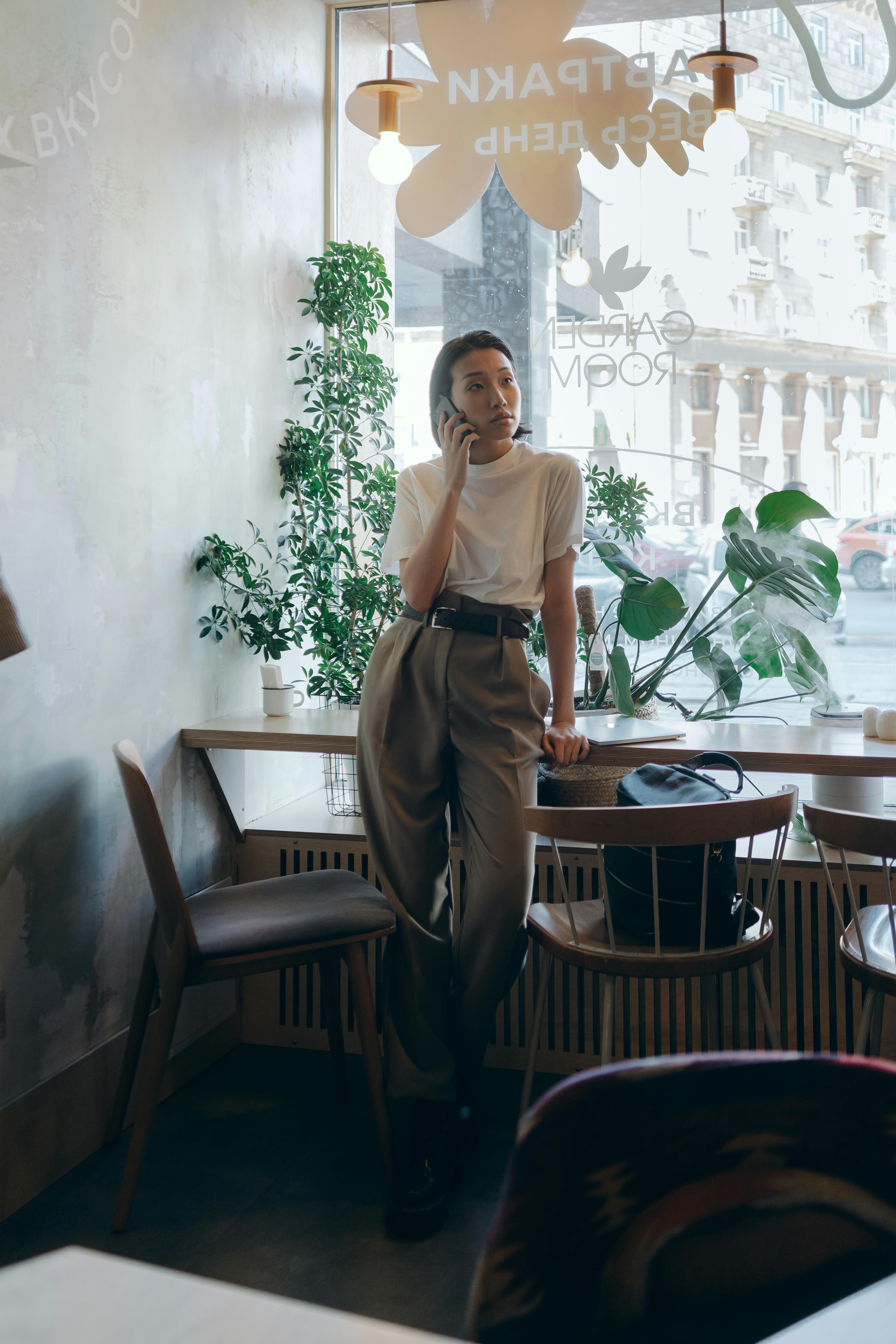 A Businesswoman Having a Phone Call Inside the Coffee Shop · Free Stock ...
