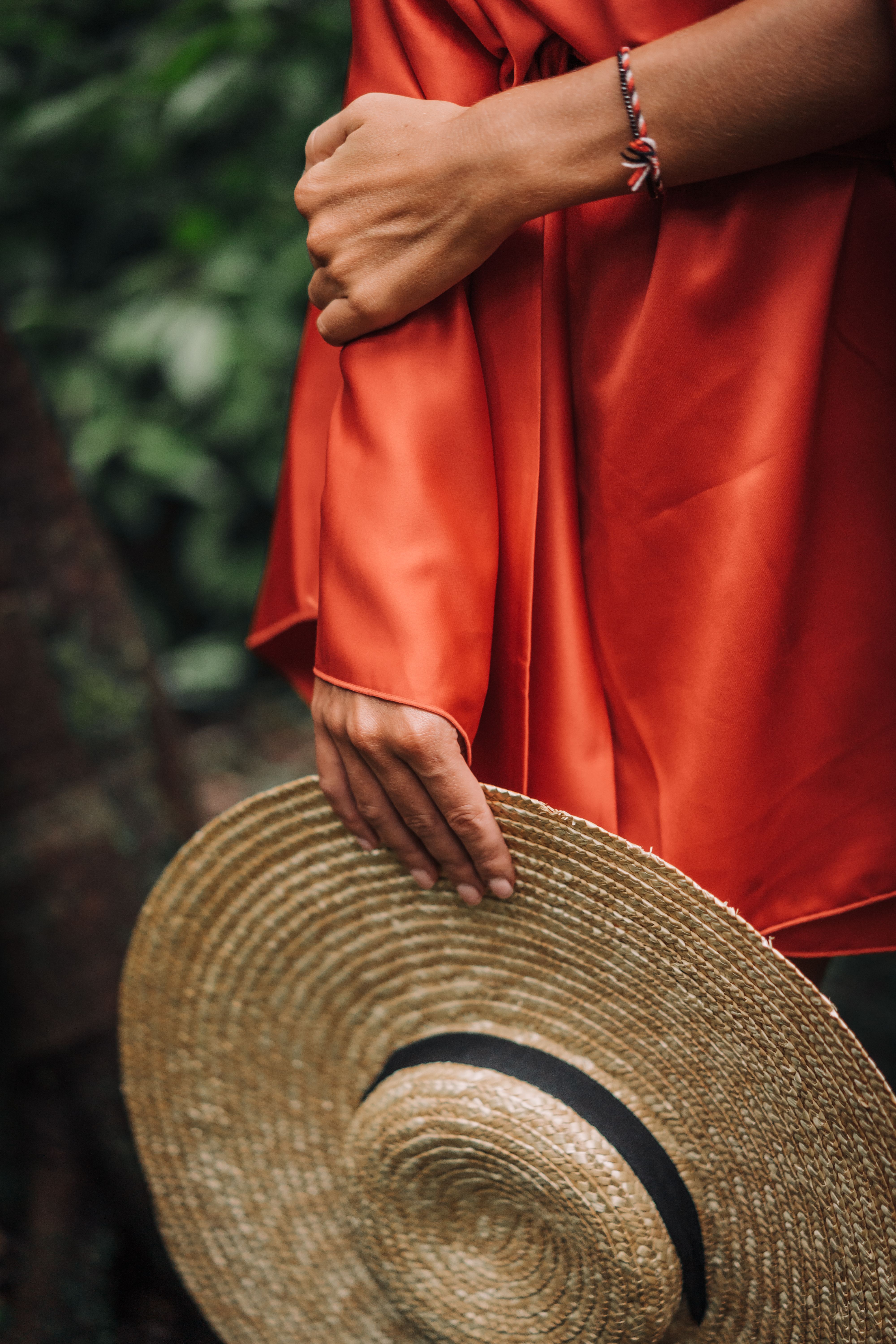 Photo of a Person in a Silk Cloth Holding a Sunhat · Free Stock Photo