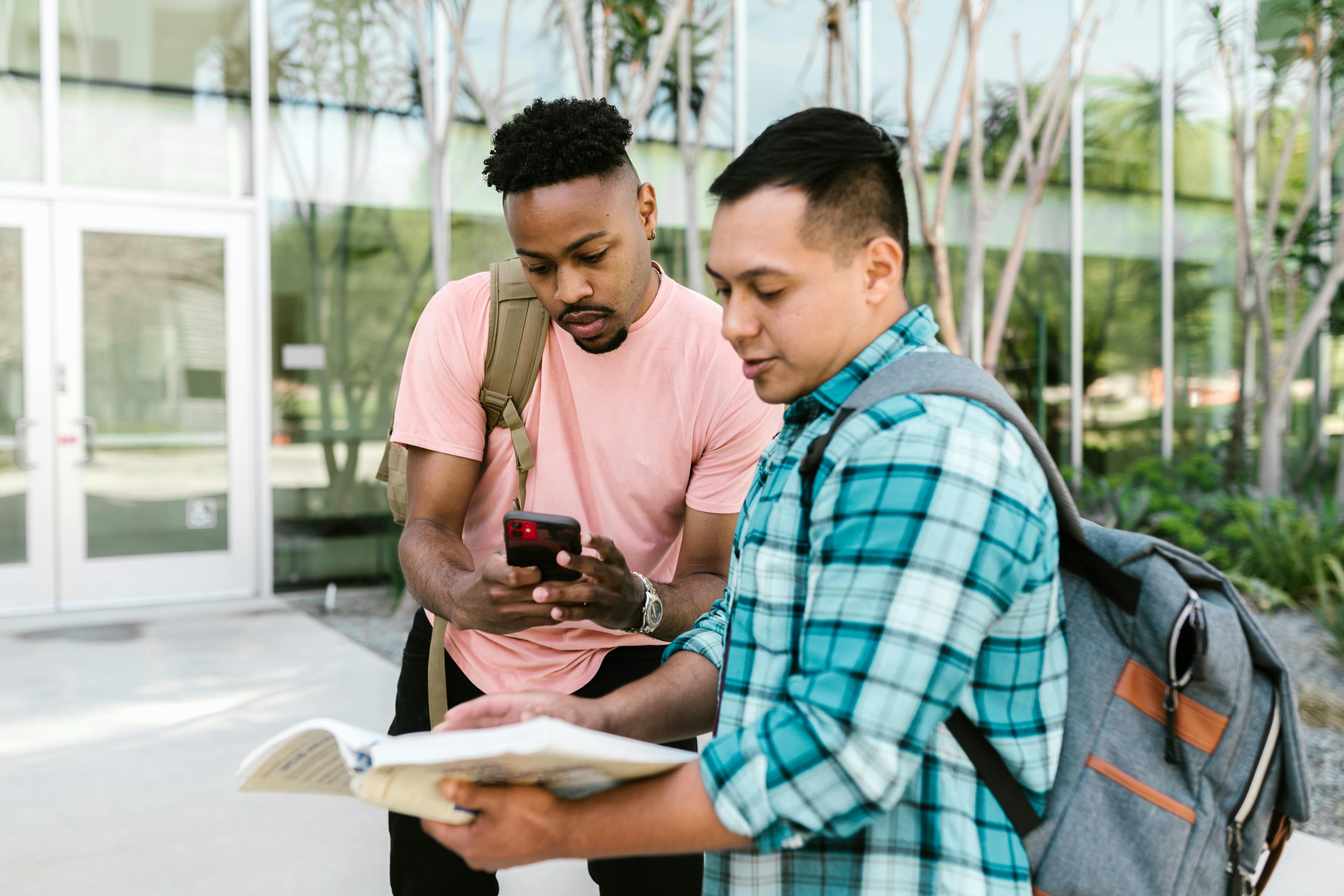 Black man grabbing student near university · Free Stock Photo