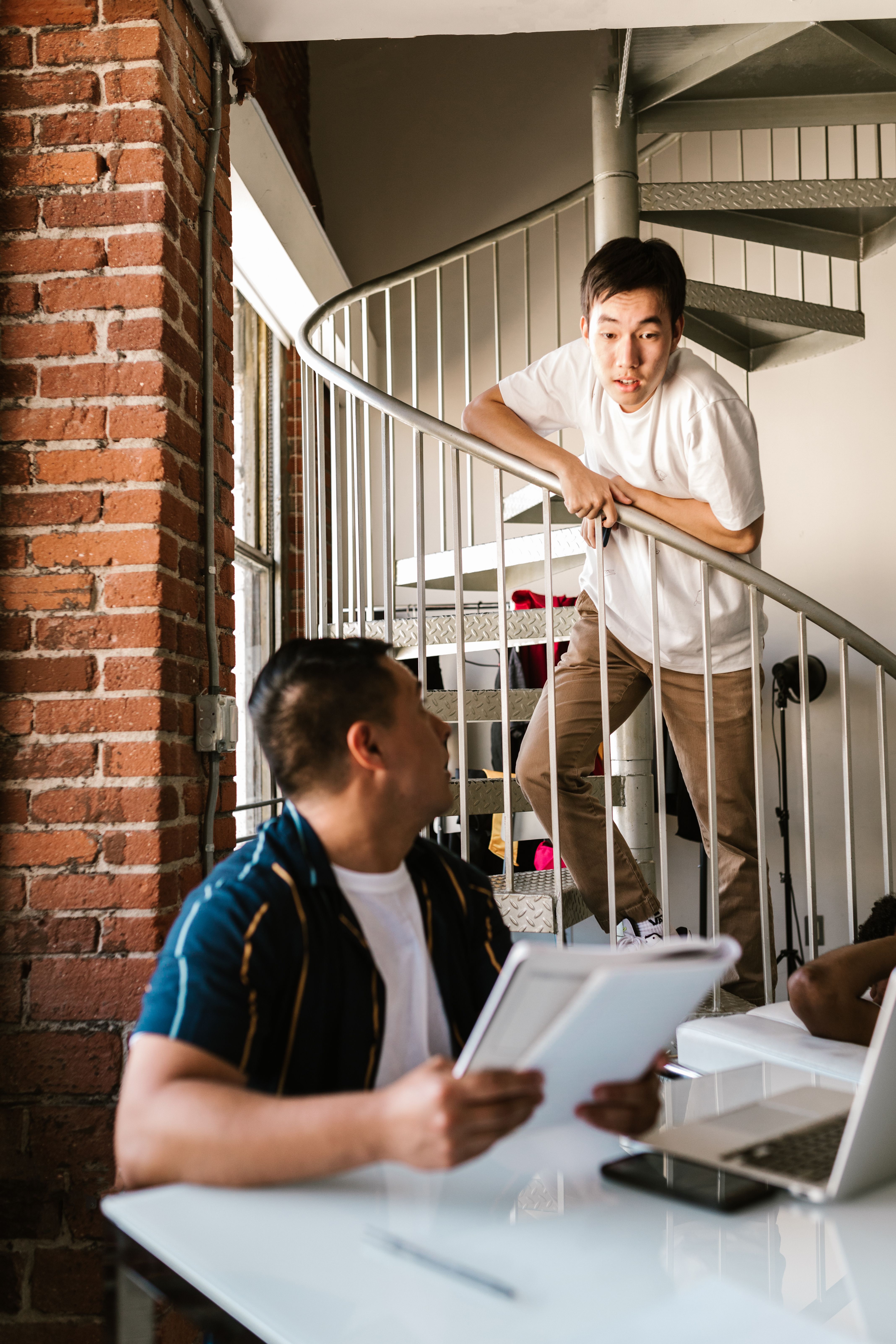 Men Talking Beside the Stairs · Free Stock Photo