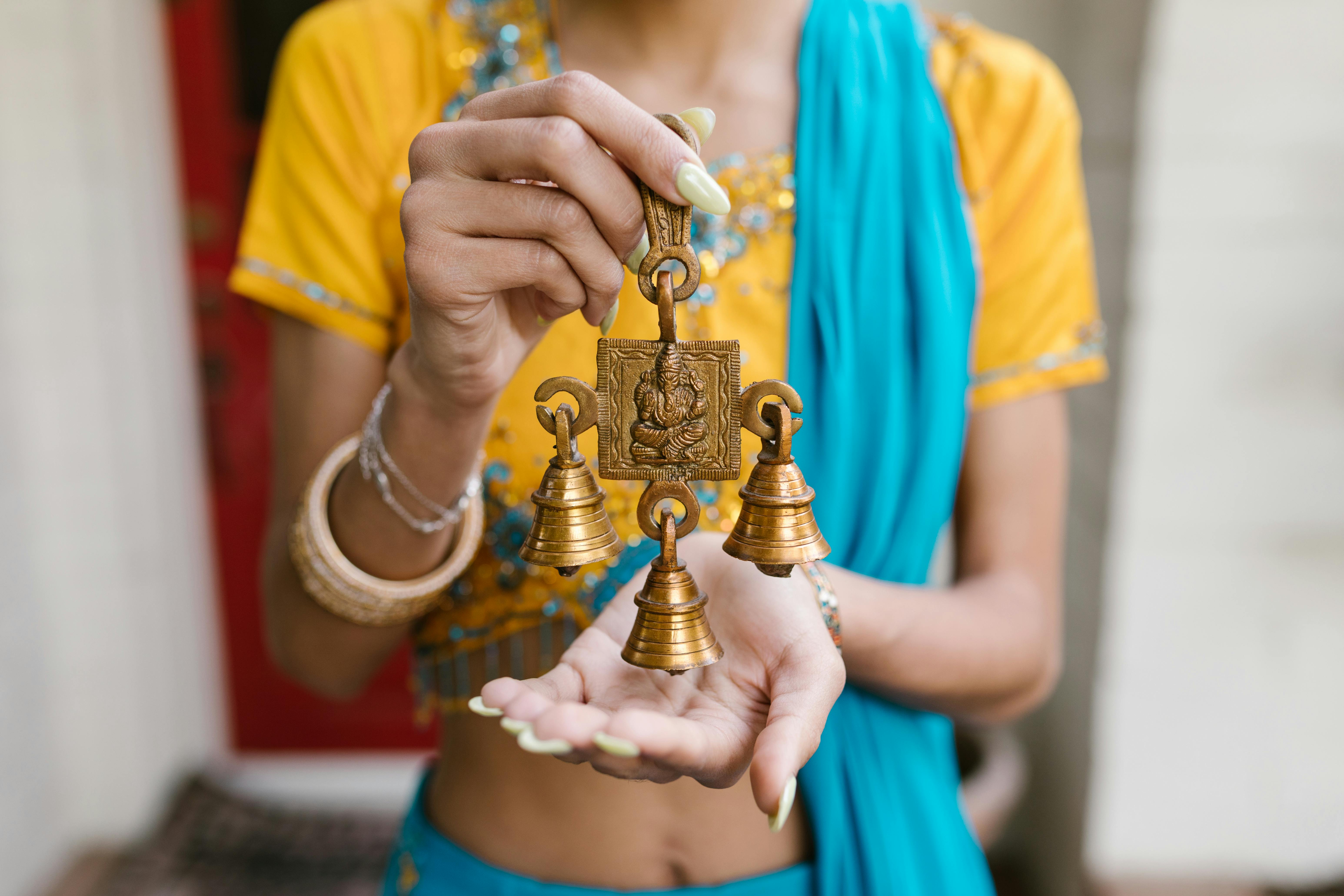 Woman Wearing Sari Holding a Traditional Bell · Free Stock Photo