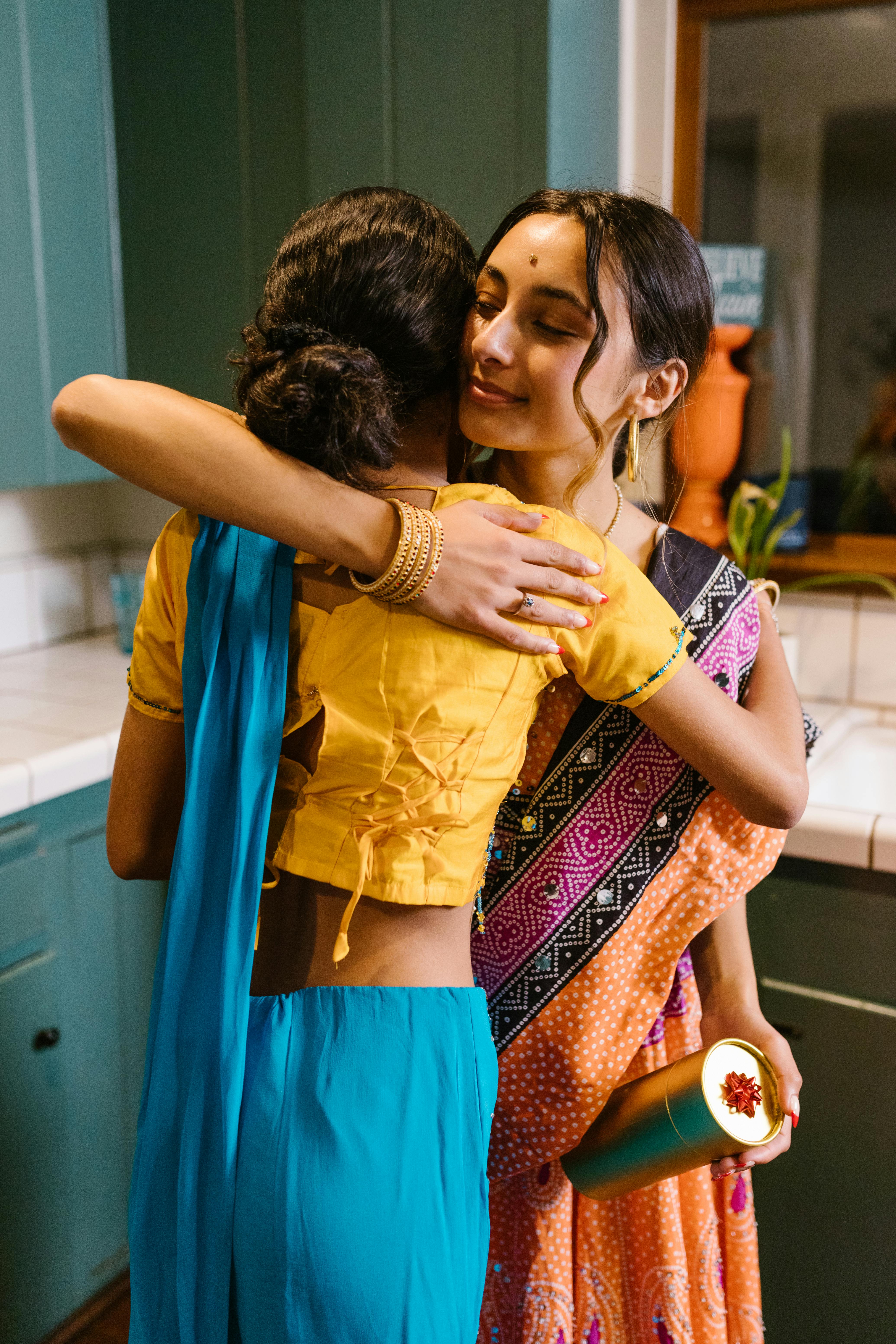 Women in Sari Hugging · Free Stock Photo