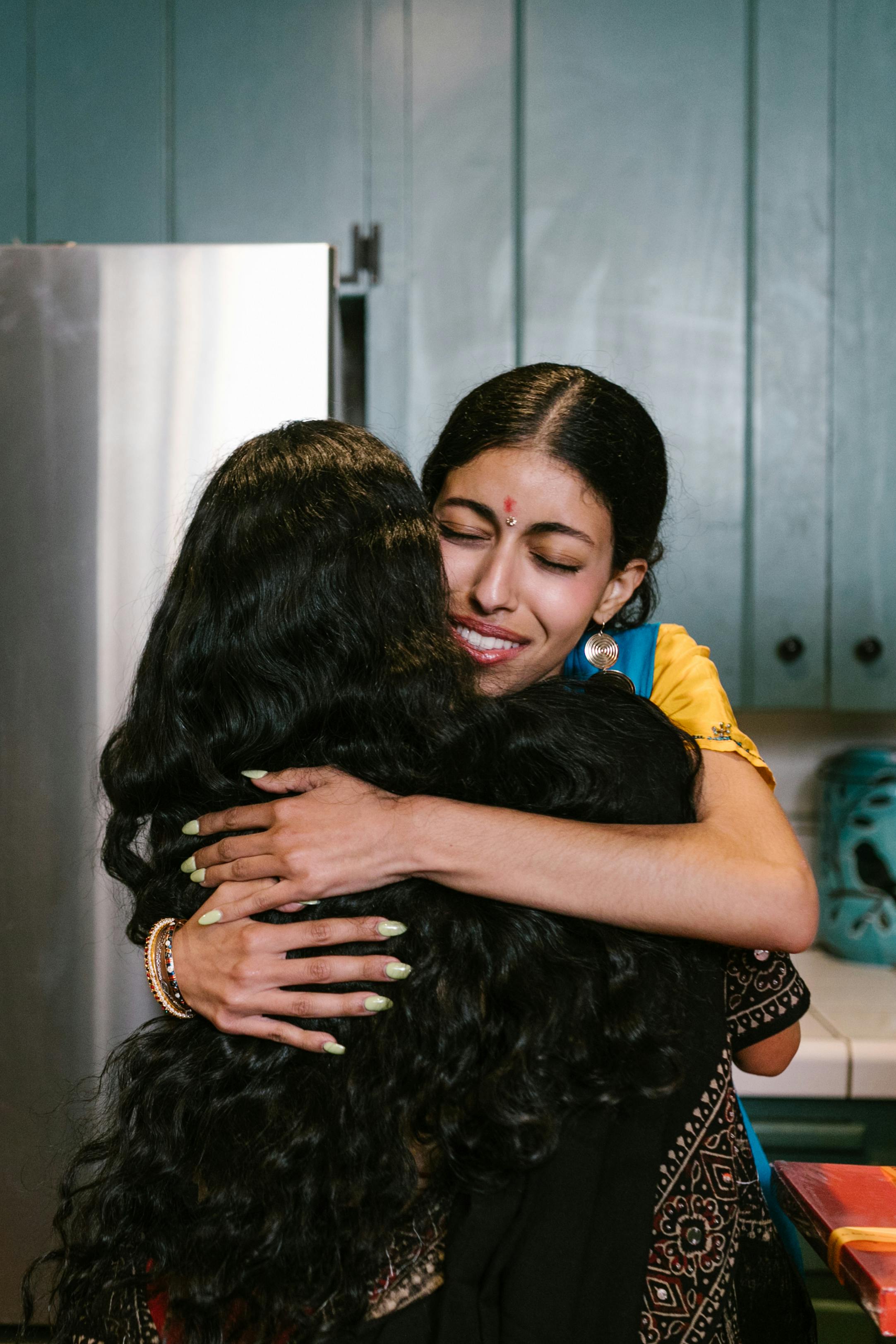 Woman in Yellow and Blue Dress Hugging Woman in Black Dress · Free ...