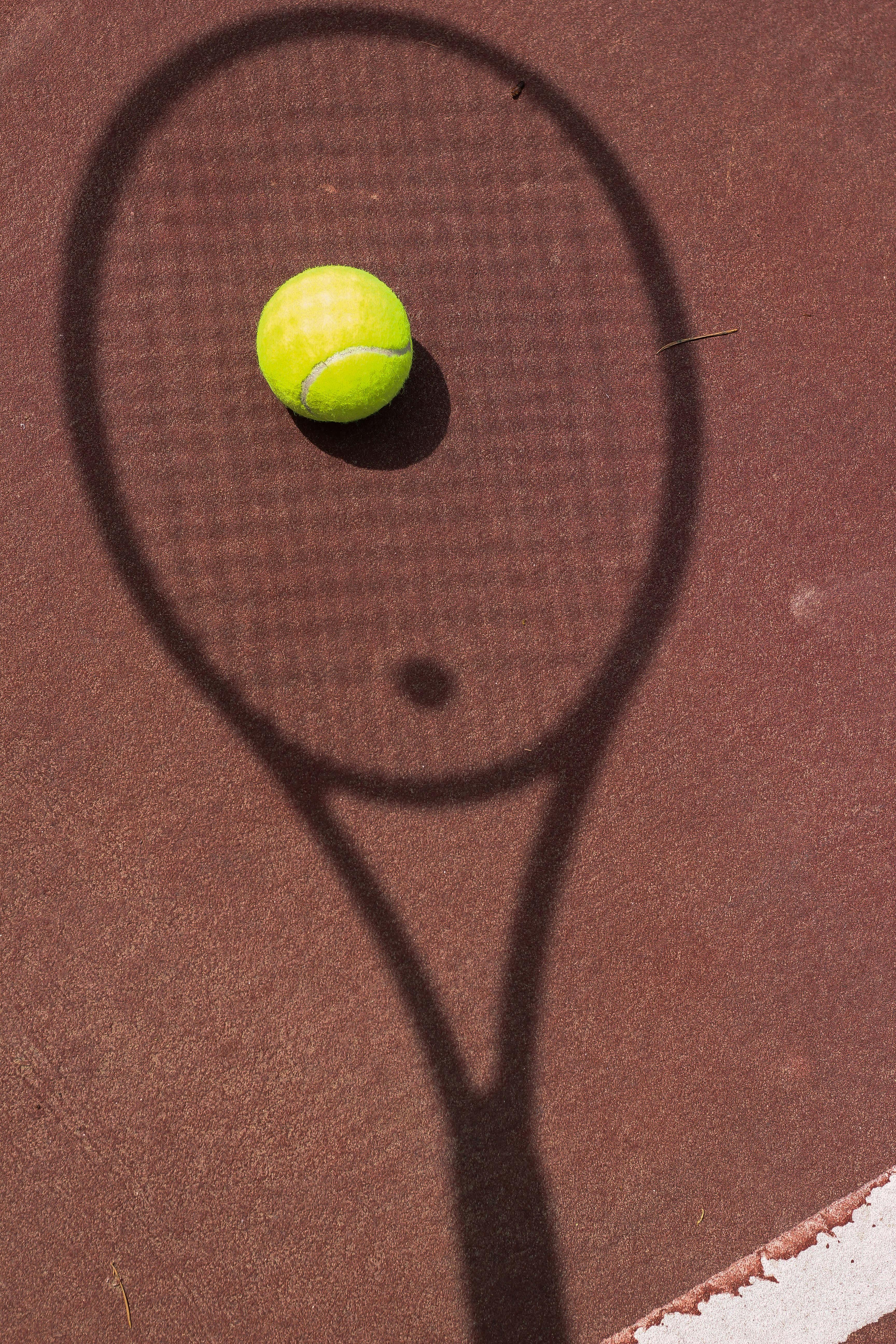 Tennis Ball and Shadow of Racket · Free Stock Photo