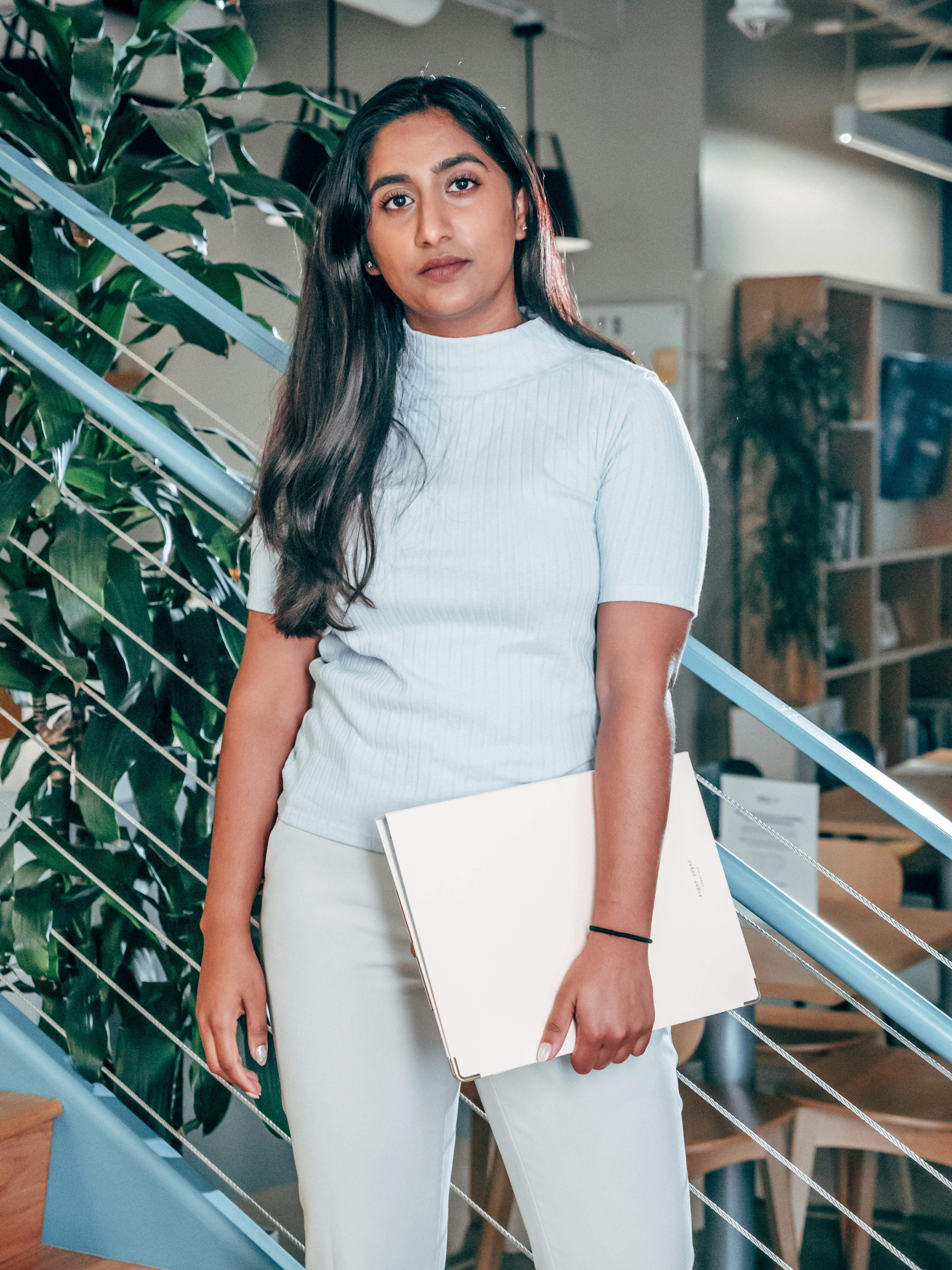 Female Employee leaning on Handrails · Free Stock Photo