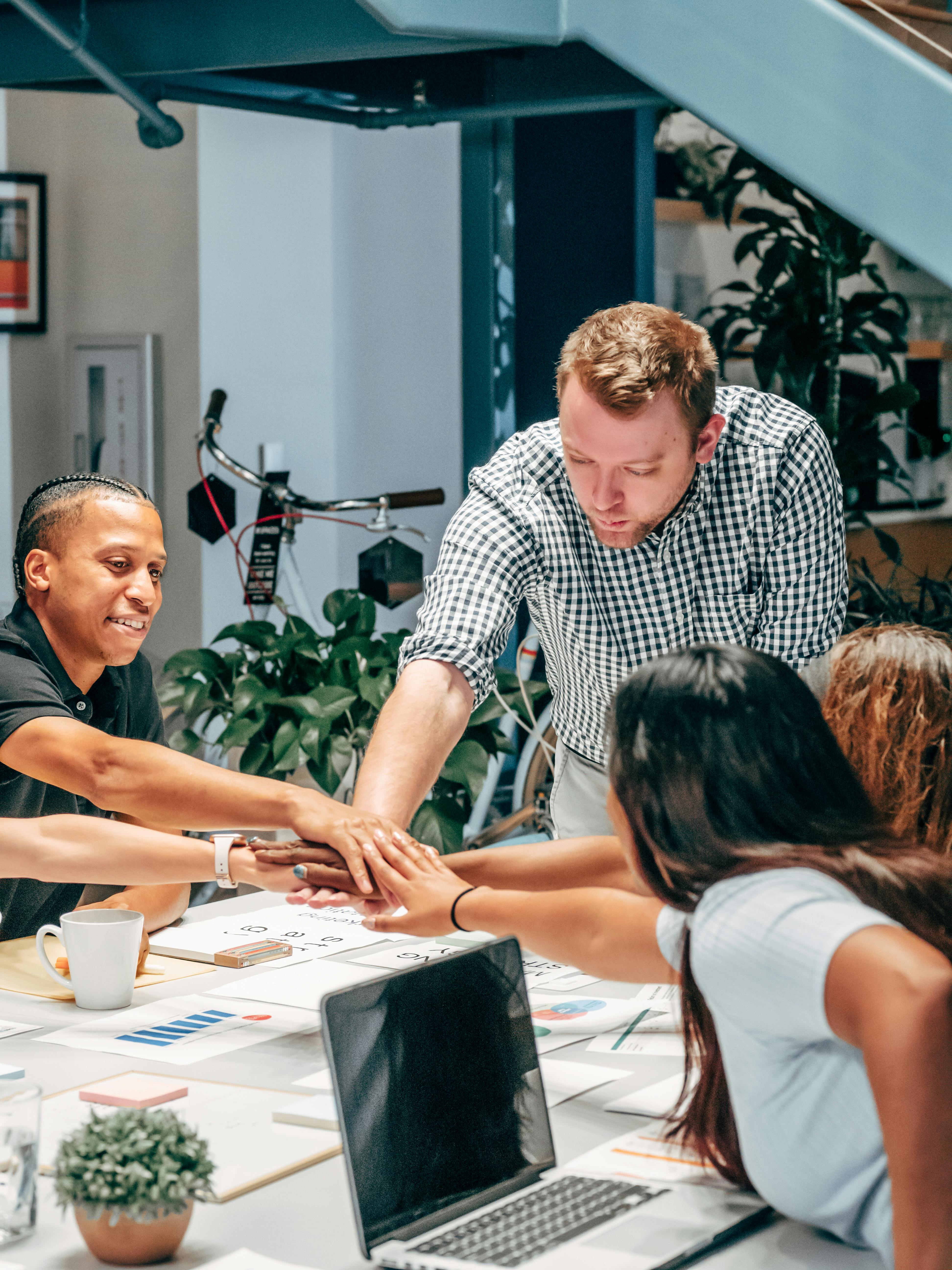 A Group of People Stacking Hands · Free Stock Photo